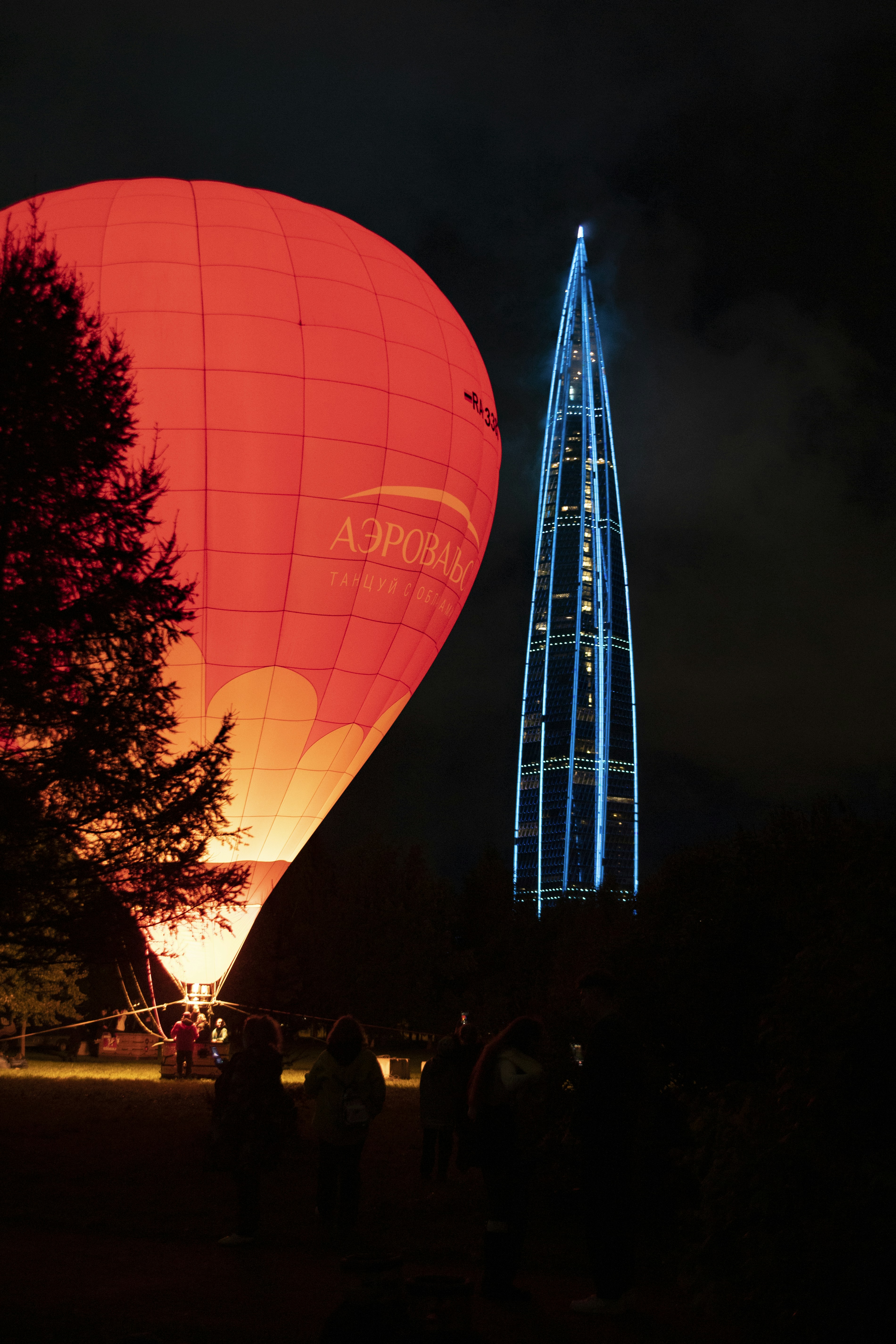 Illuminated Dreams: A Balloon's Ascent Against the Night Sky
