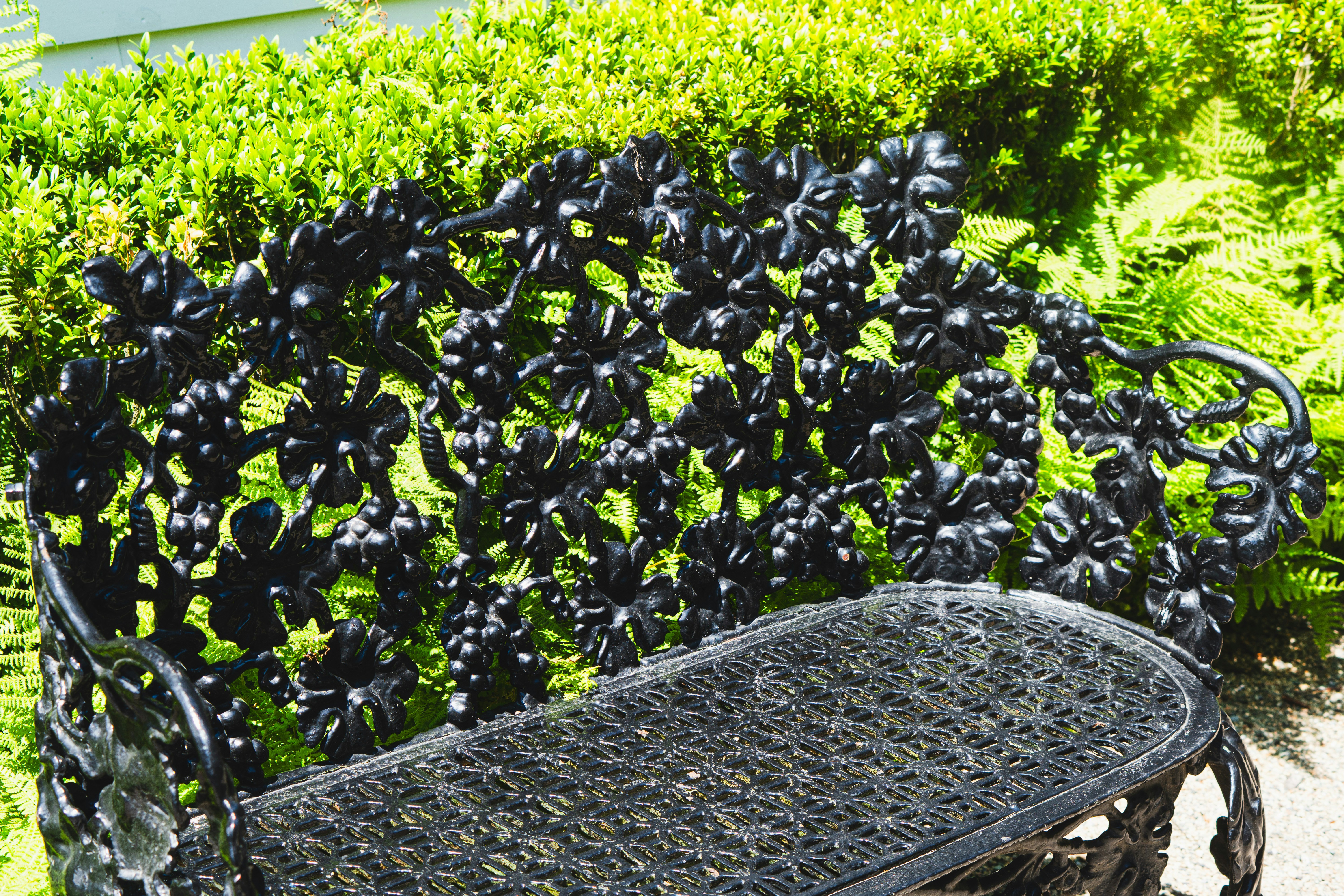 Black bench with ornate design | Ornate black metal bench with floral design