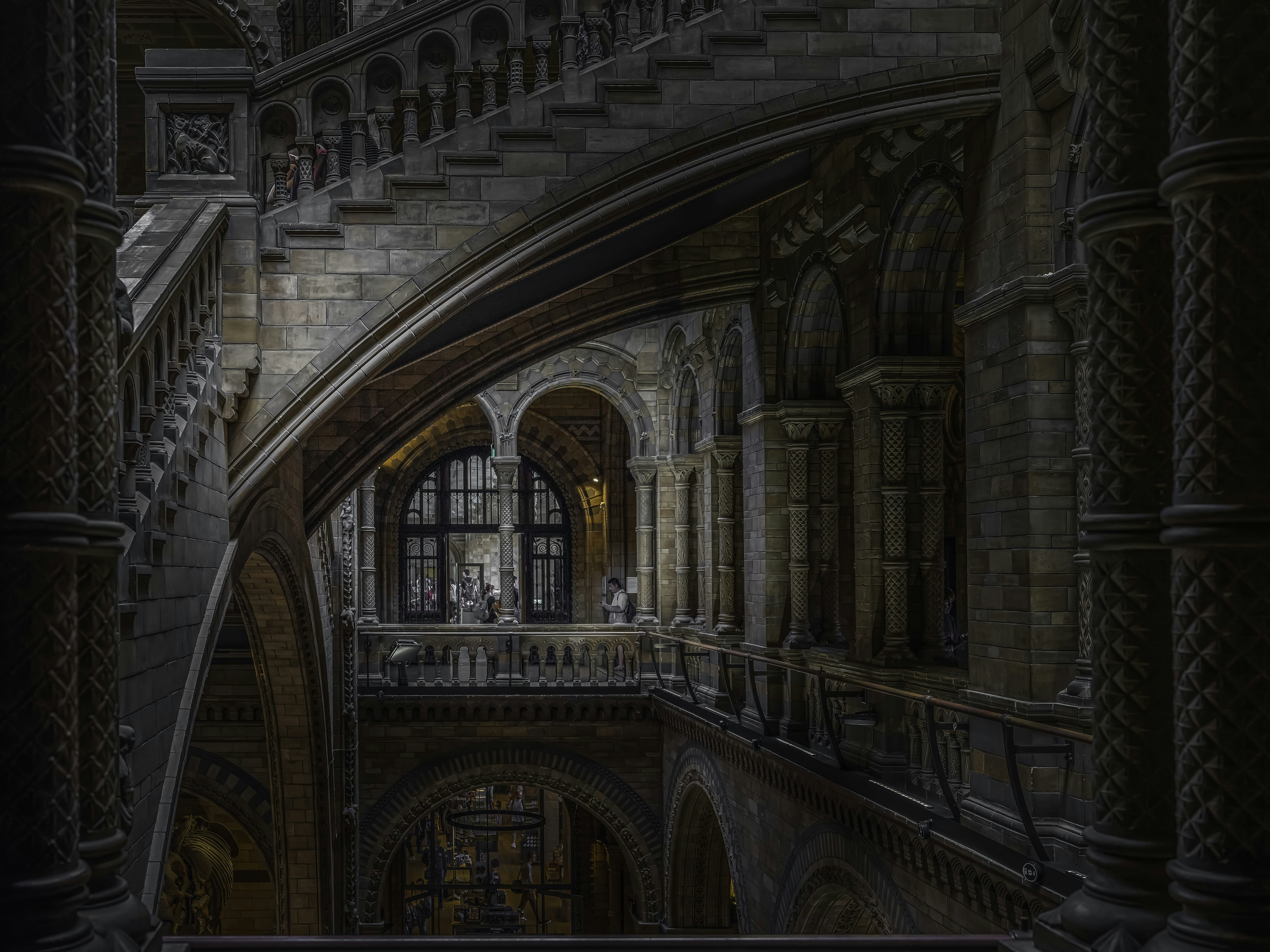 This view reminded me of Hogwarts School of Witchcraft and Wizardry from Harry Potter. Natural History Museum, London | Ornate stone staircase with arched windows in museum