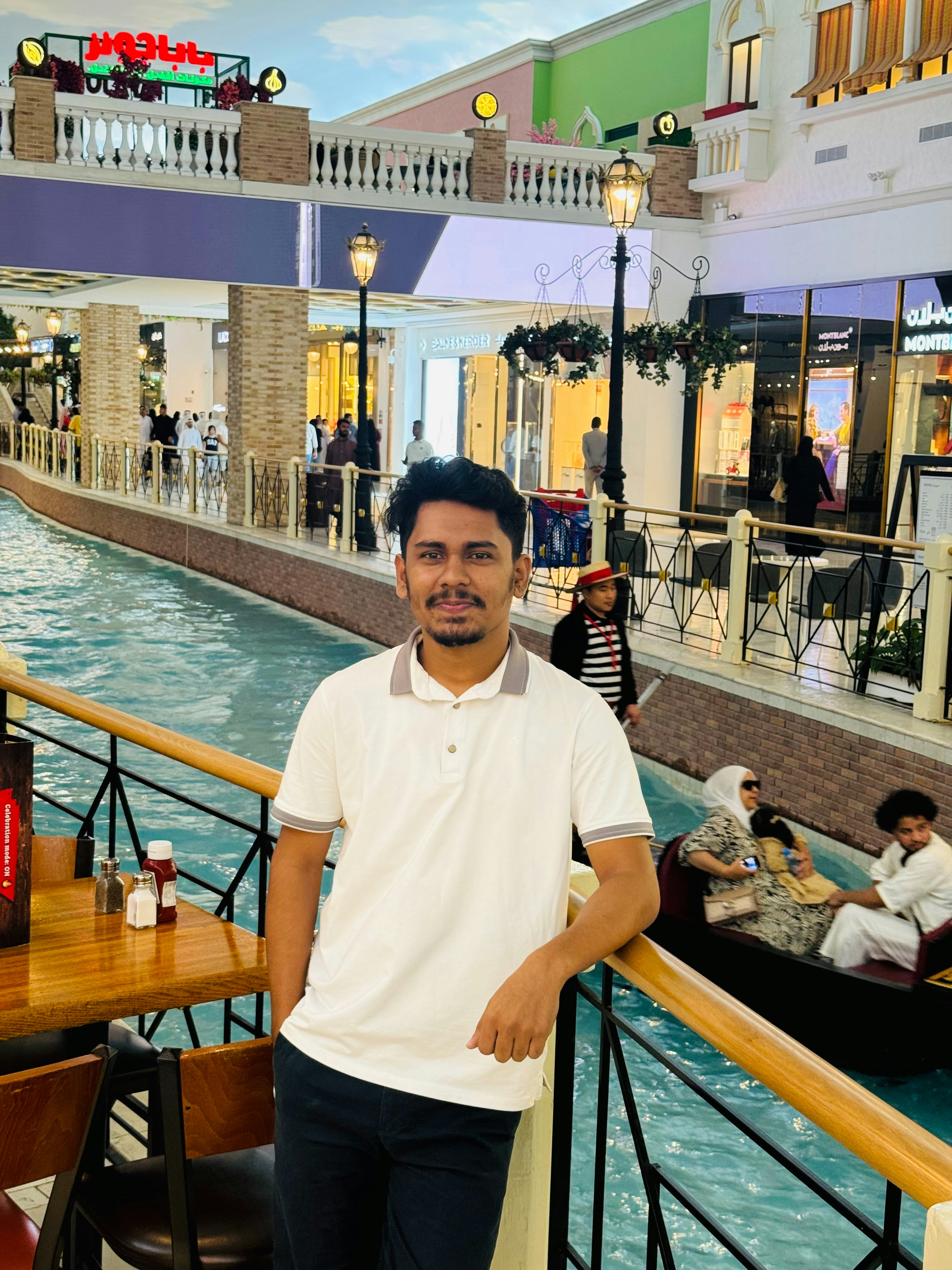 Man posing by a canal in a shopping mall. photo – Free Tourism Image on ...