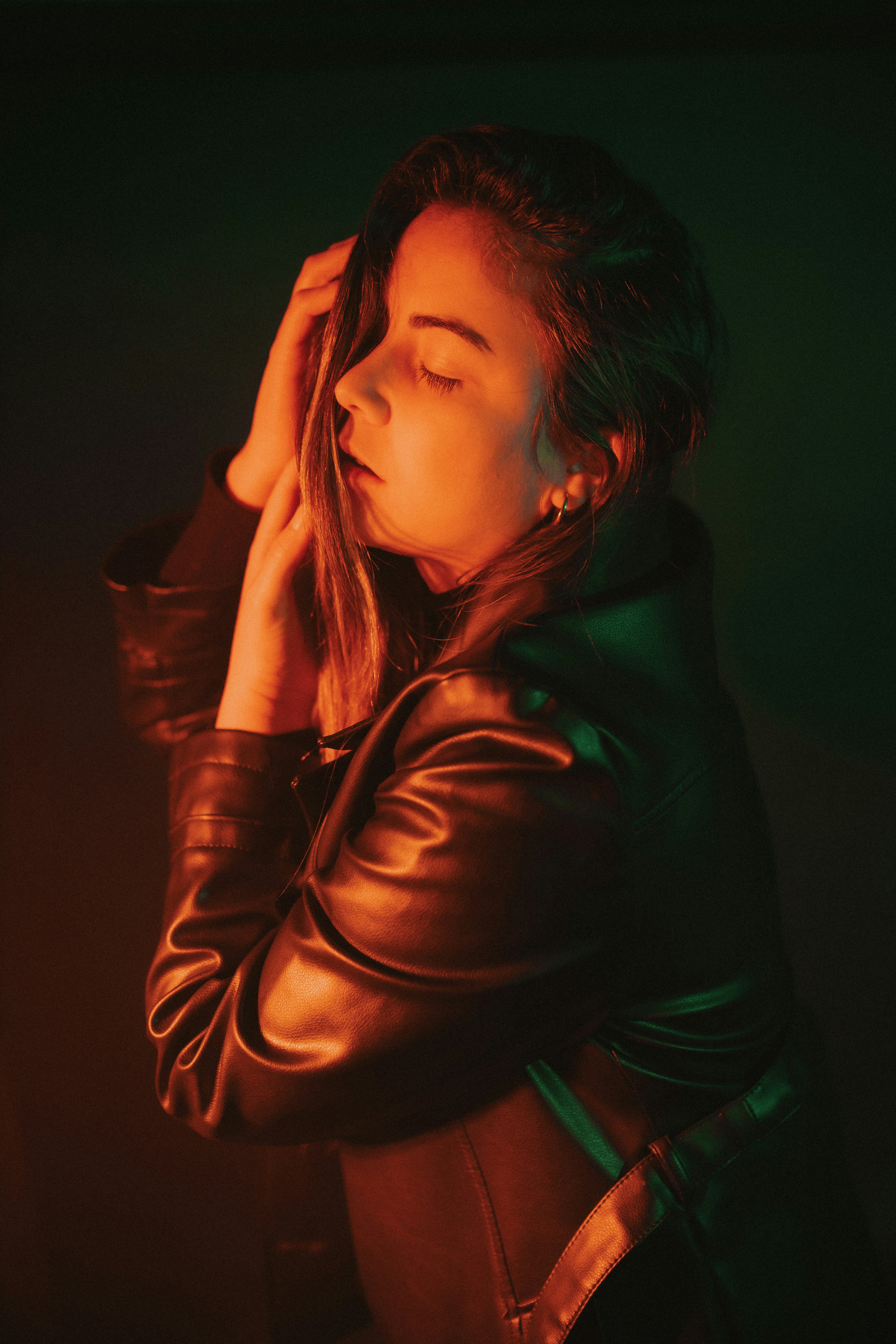 Woman in leather jacket with eyes closed