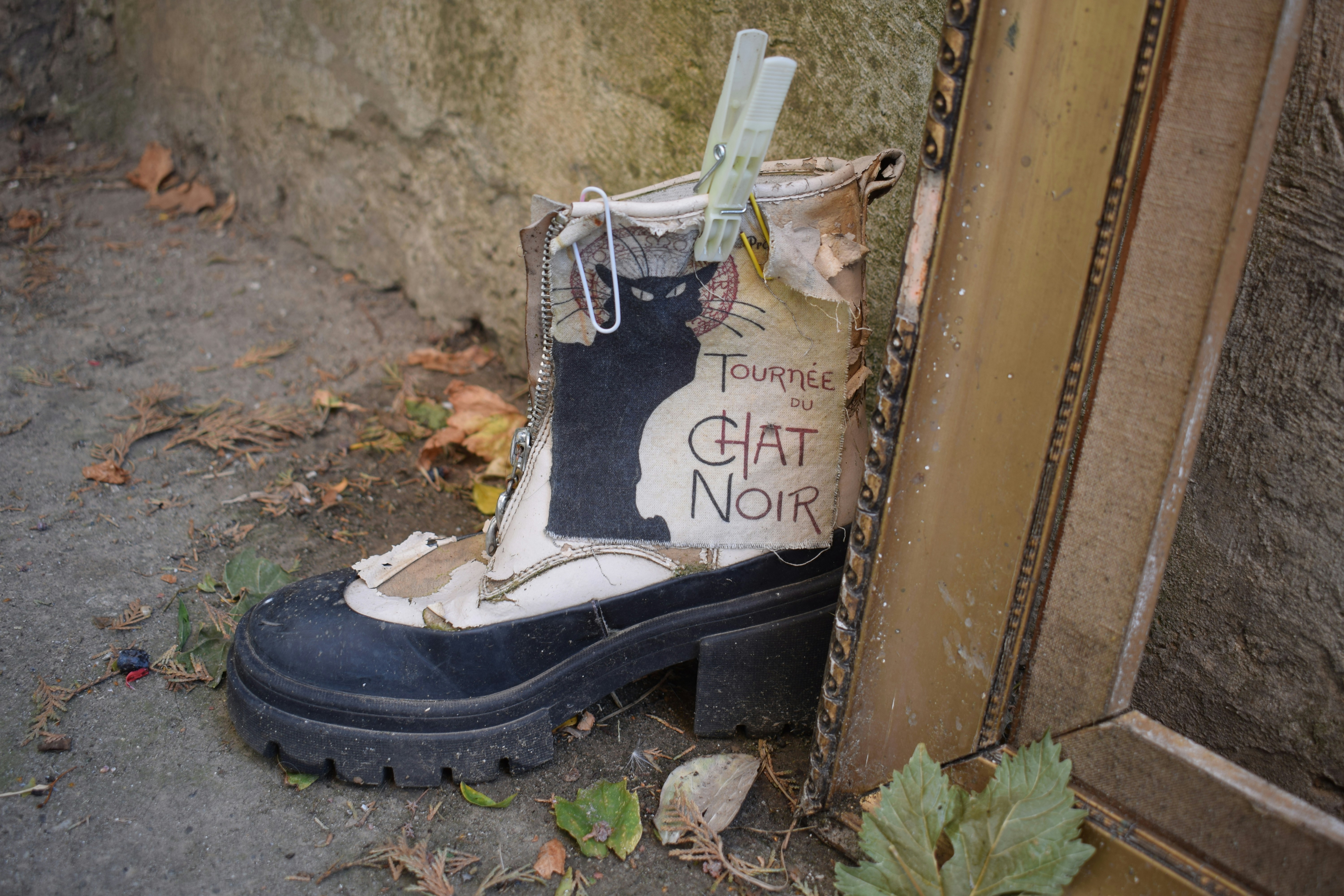 Chat Noir on a Worn Boot: Street Art in Footwear