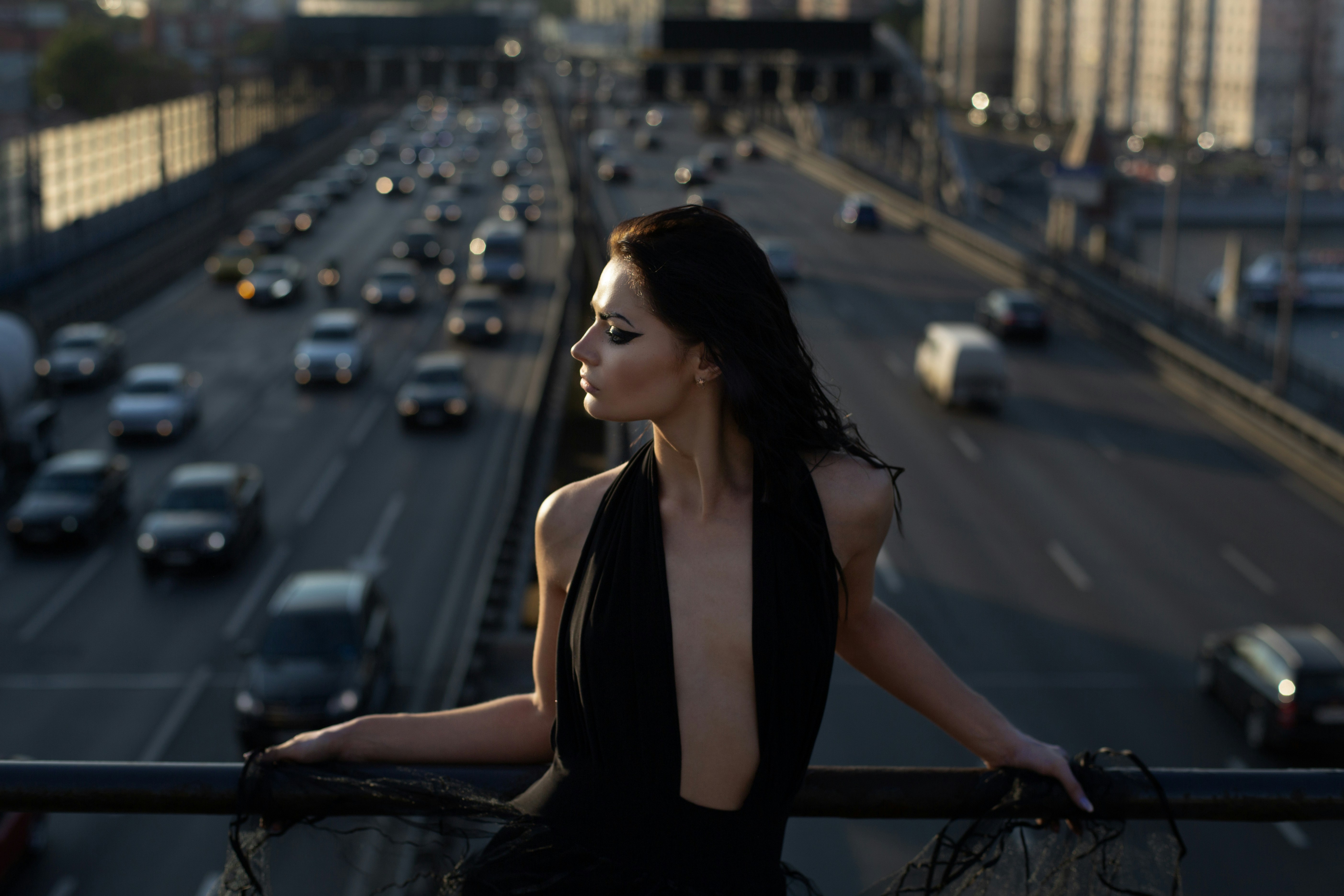 Bridge Whisper: Night Portrait Against a Flowing City Light