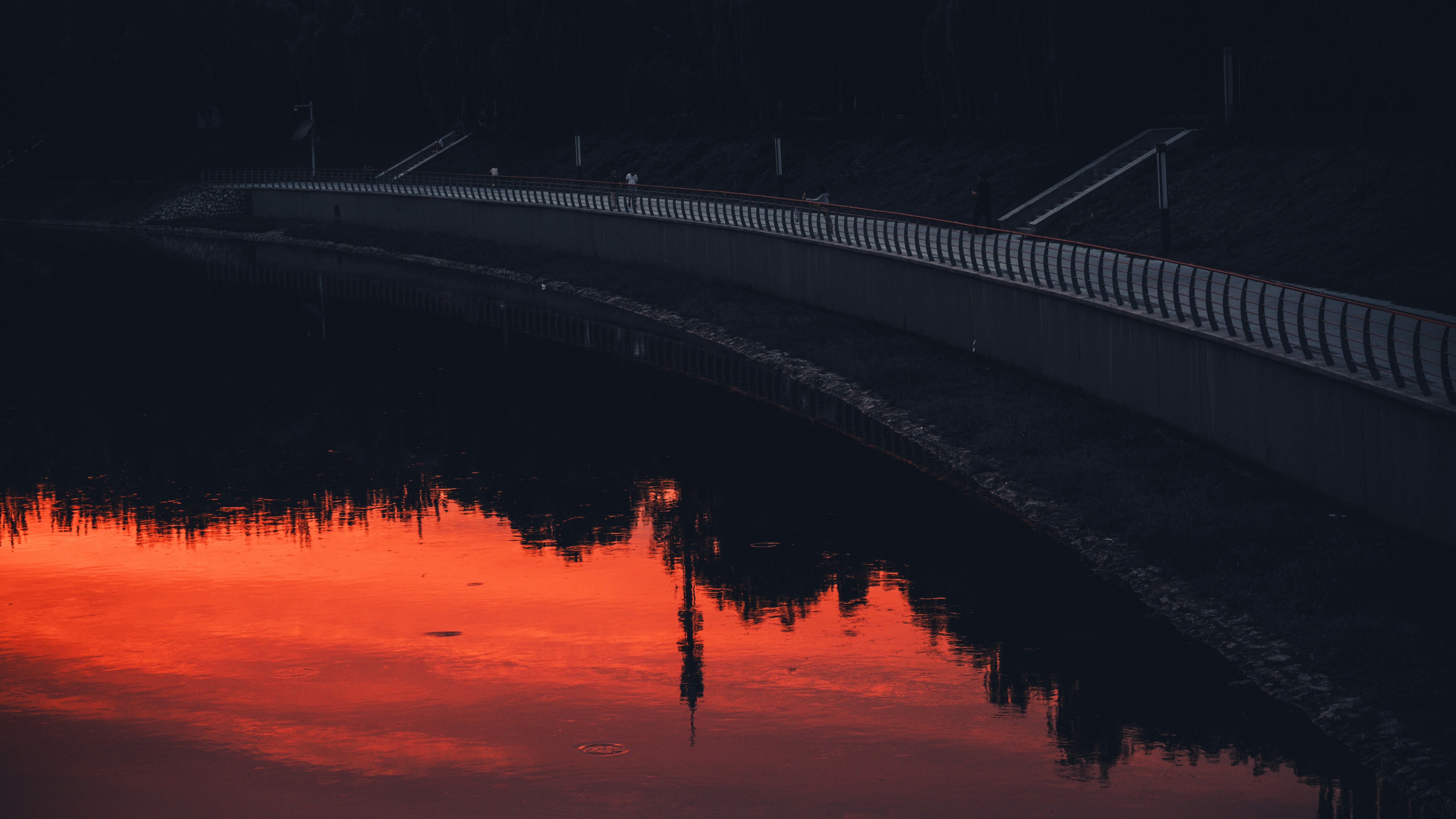 Amber Curve: Dusk Railing over Quiet Water
