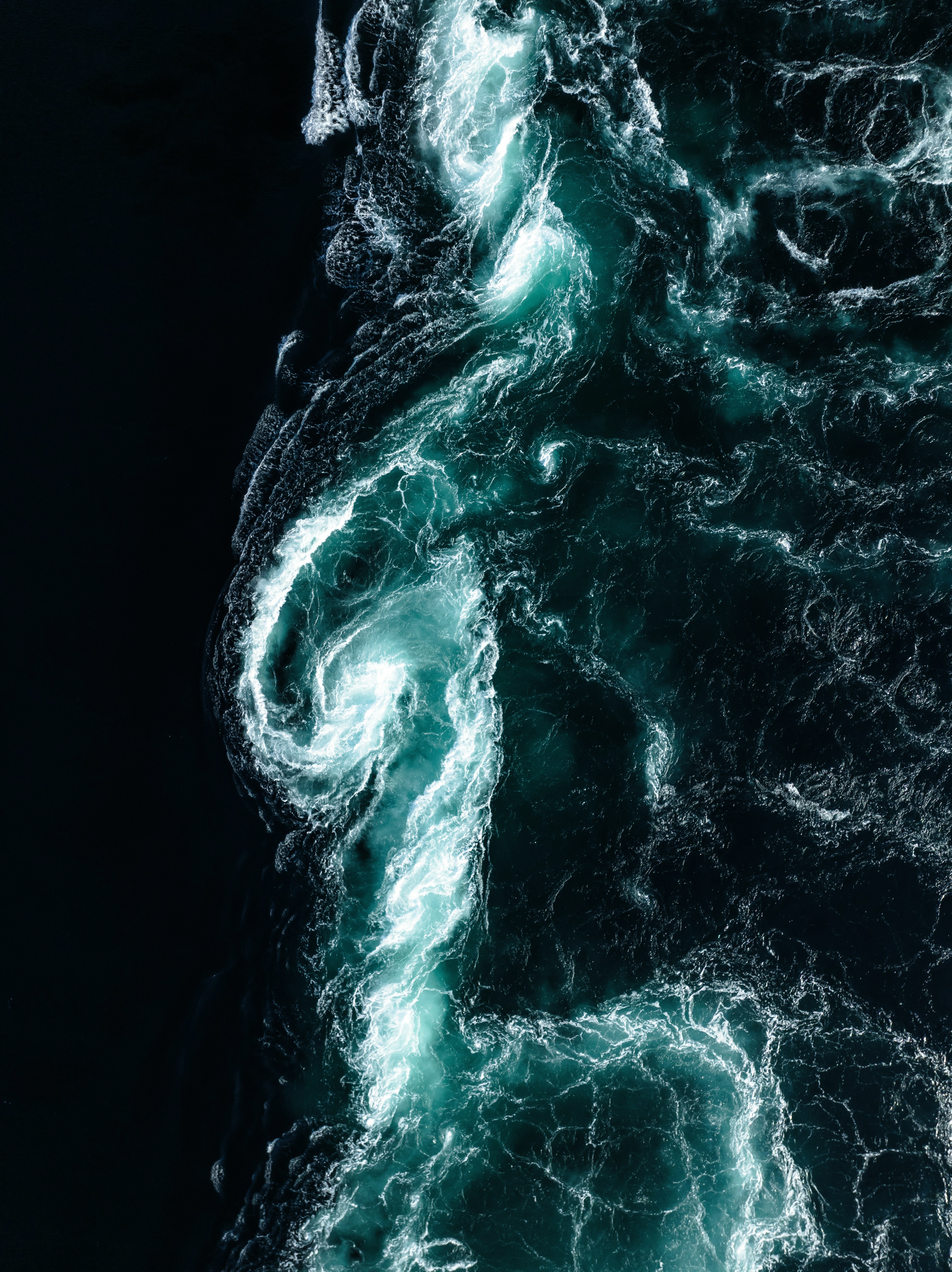Powerful ocean currents create swirling turquoise patterns.