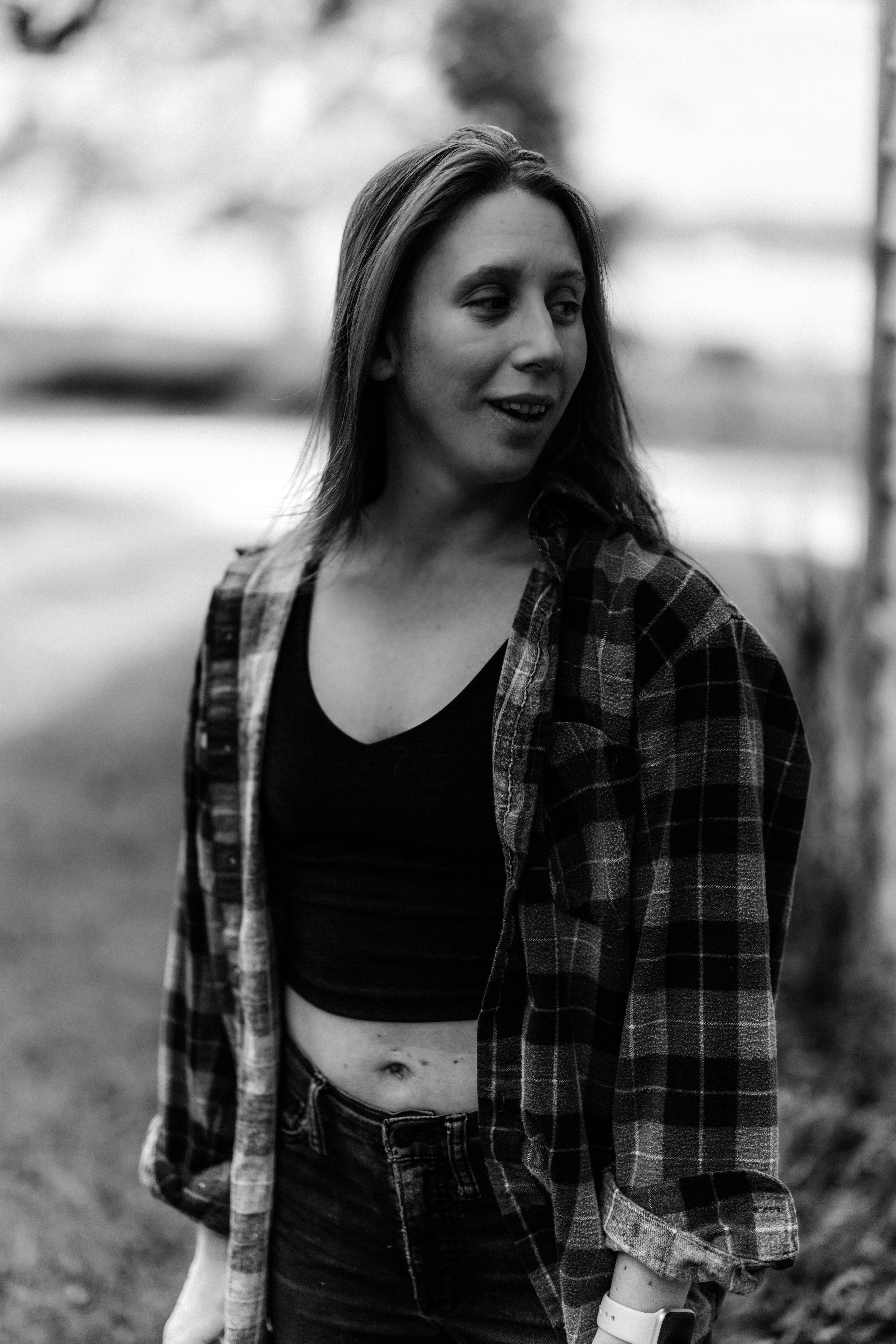 Young woman wearing a plaid shirt and crop top.
