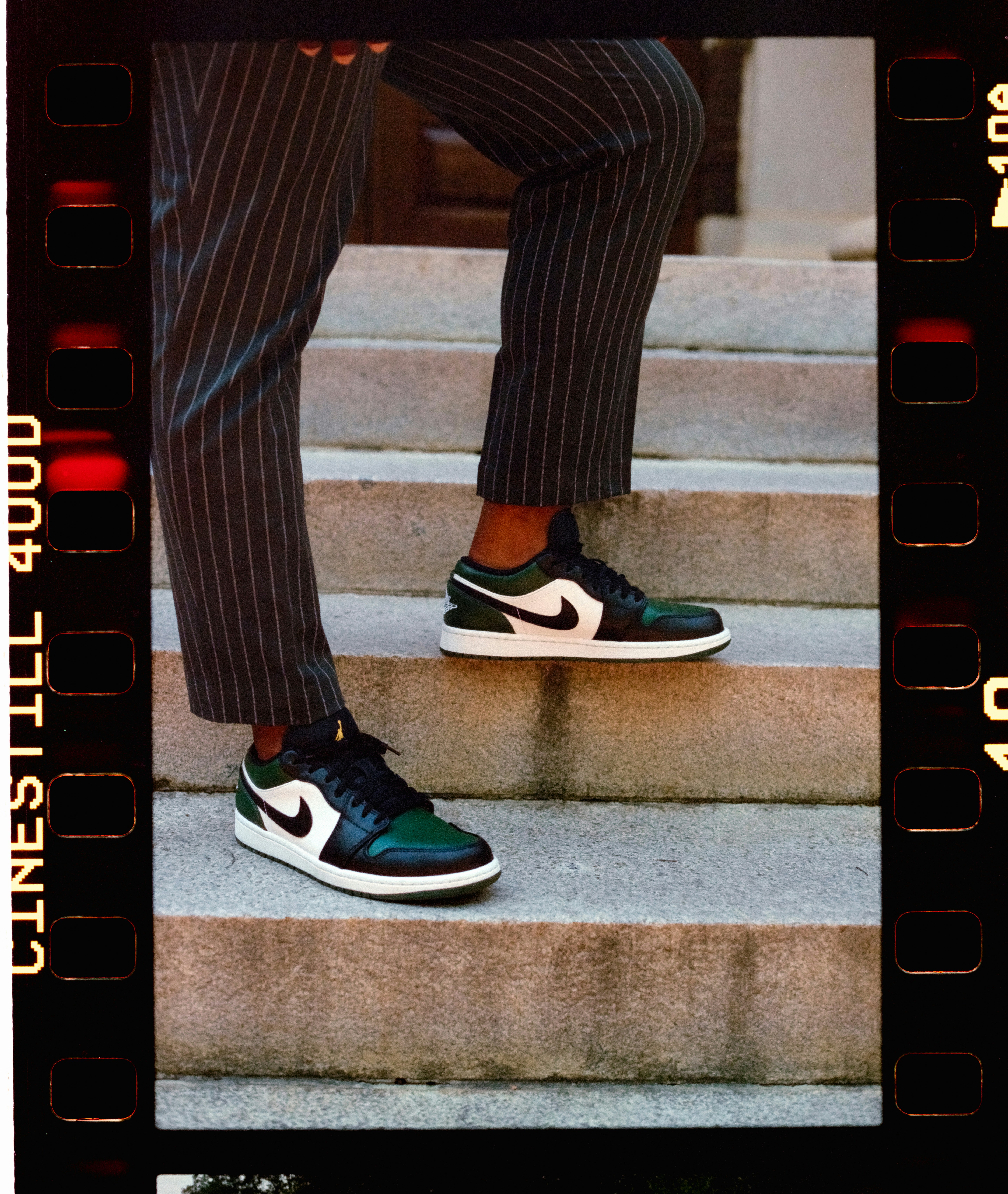 Person wearing green and white sneakers on stairs