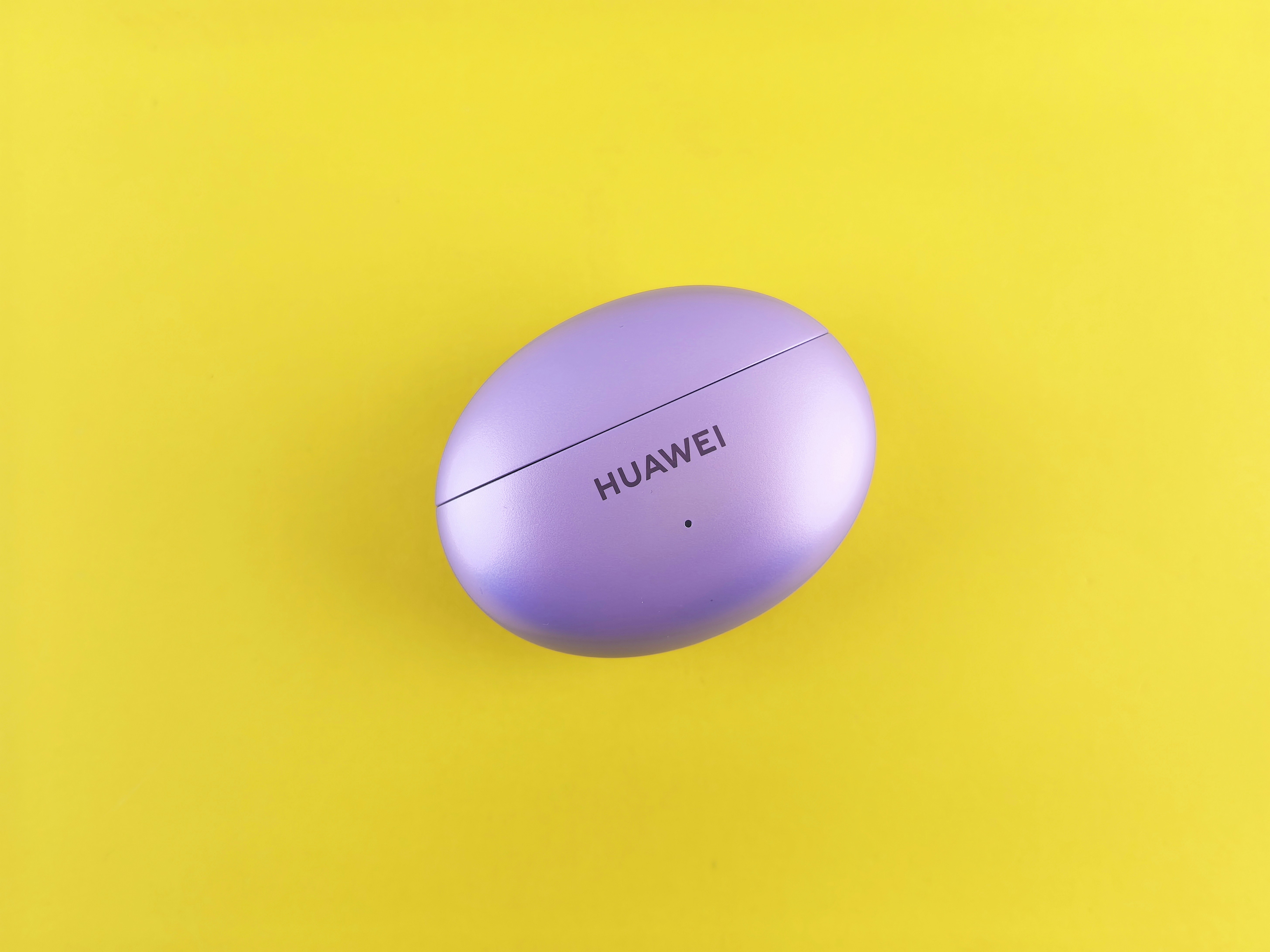 Purple huawei earbuds case on yellow background