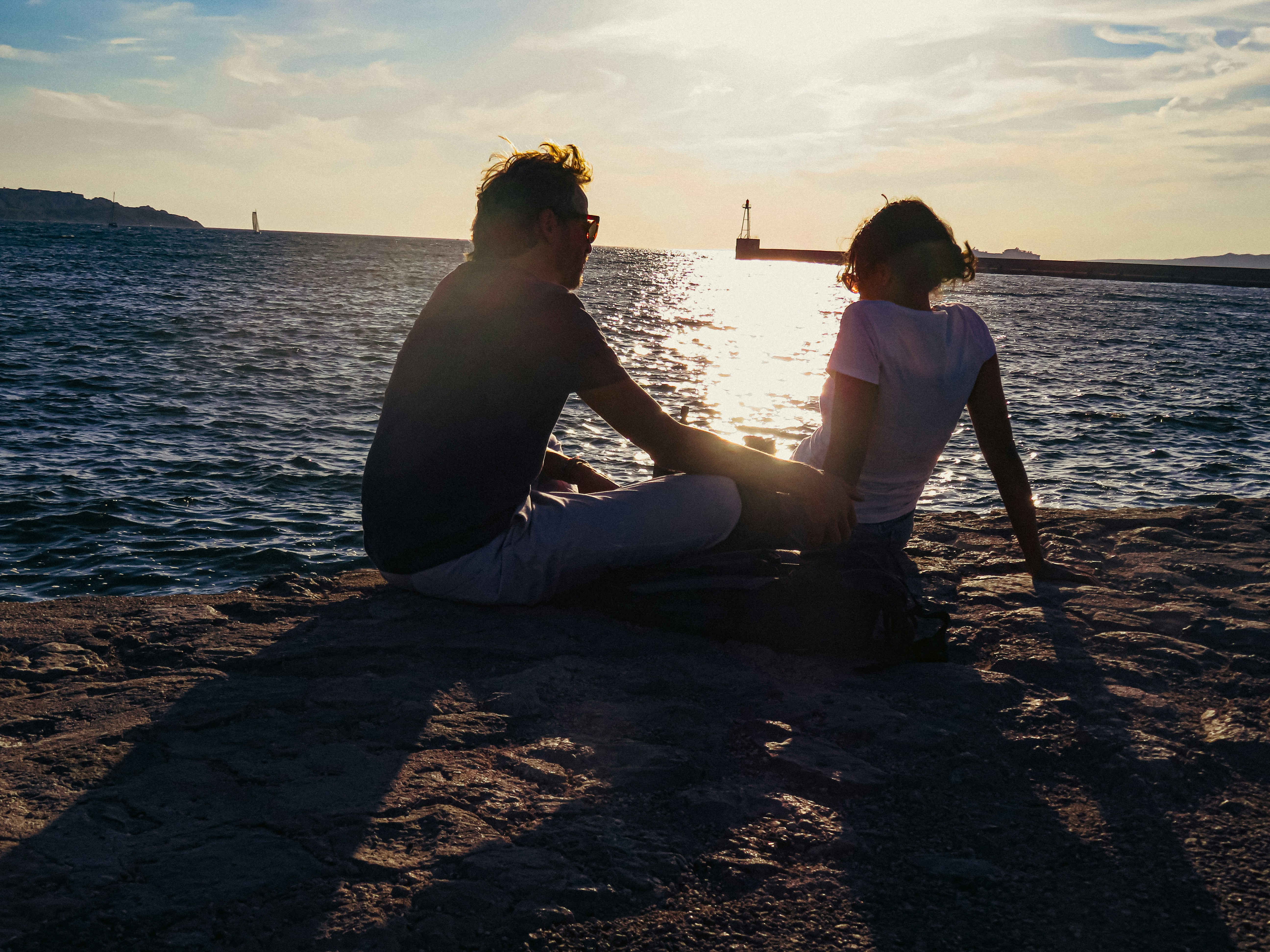 Couple watching sunset over the sea