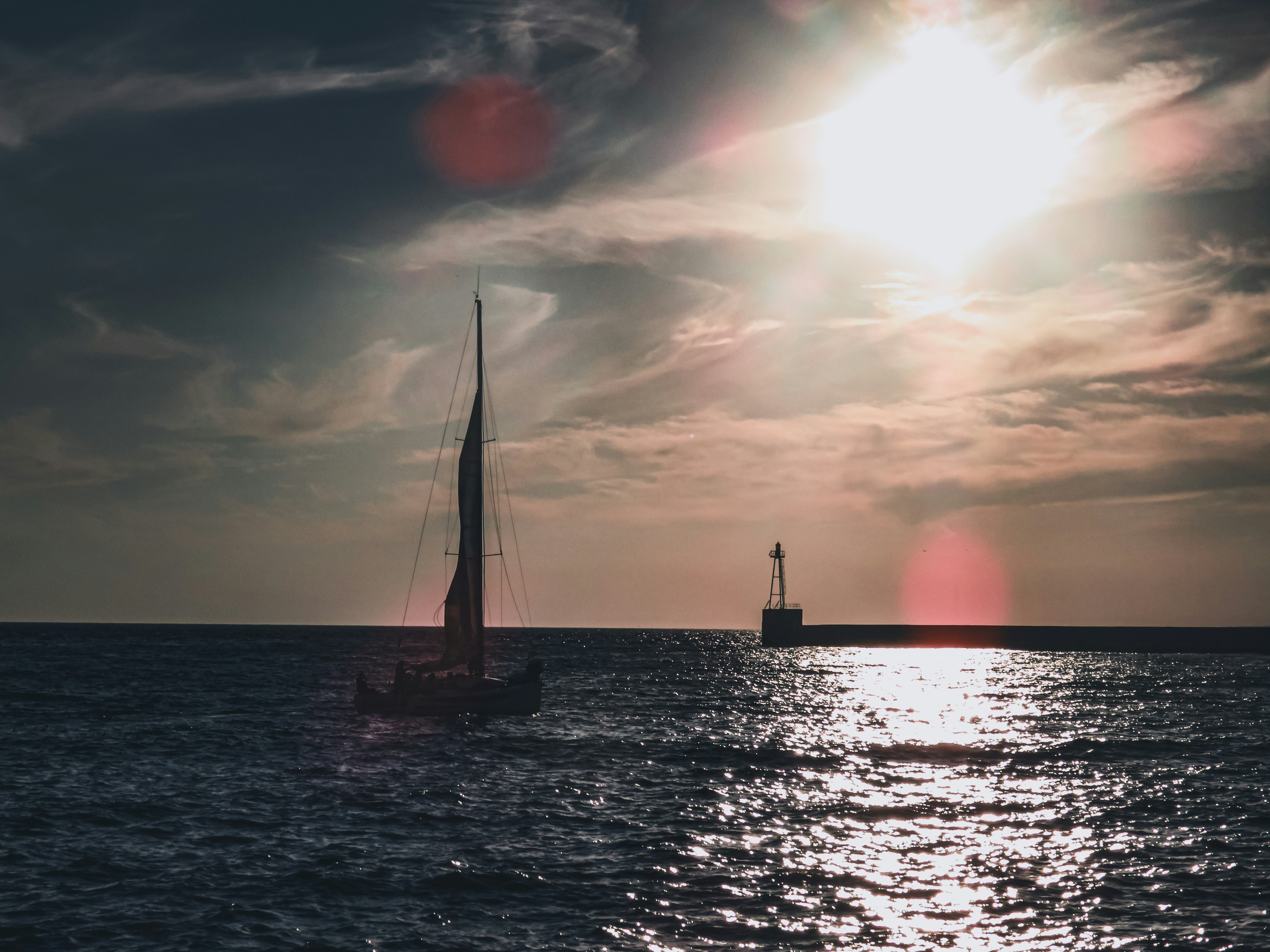 Sailing Towards the Horizon: A Dance of Light and Water