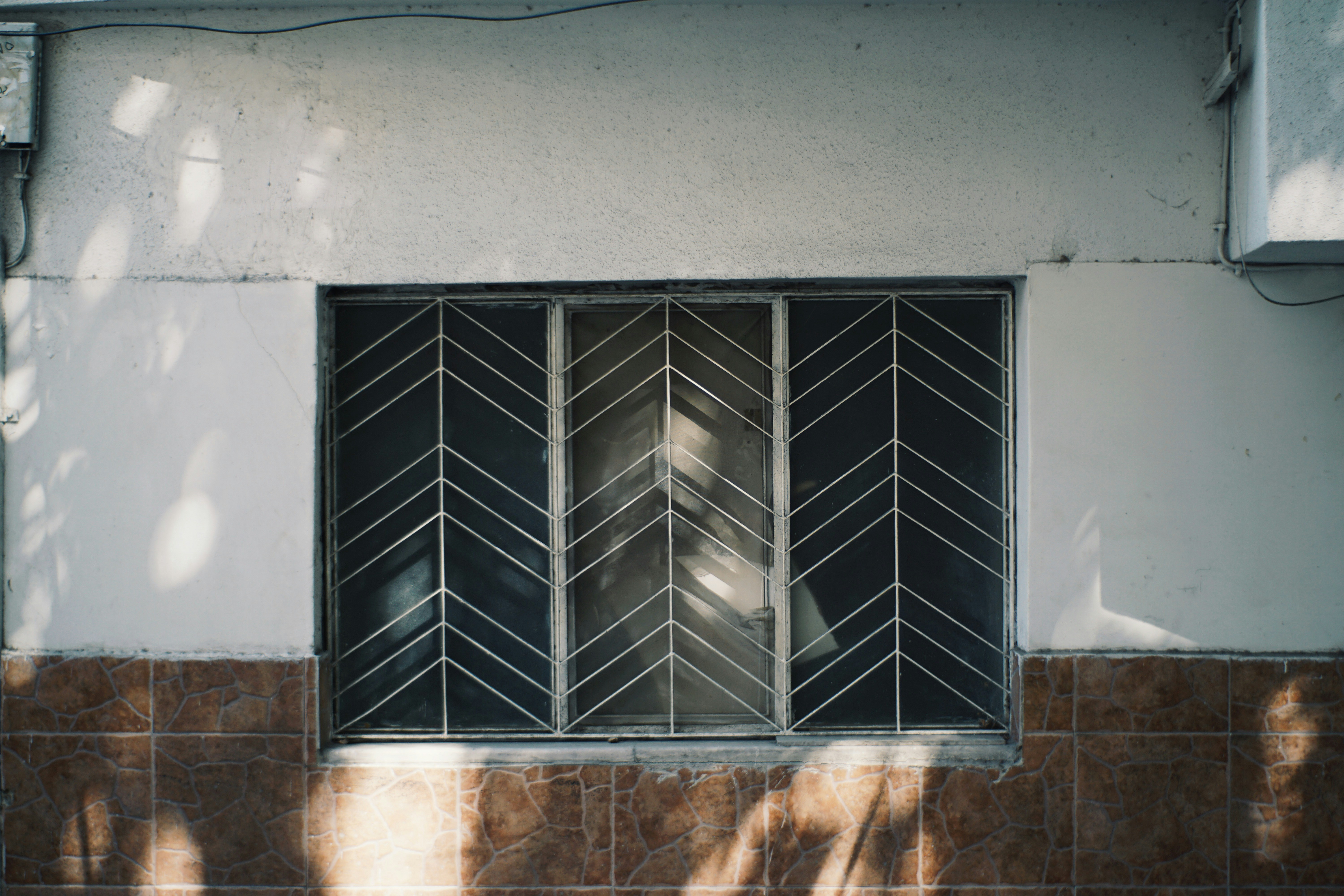 Symmetrical Grille Echo: Central Window with Shaded Geometry