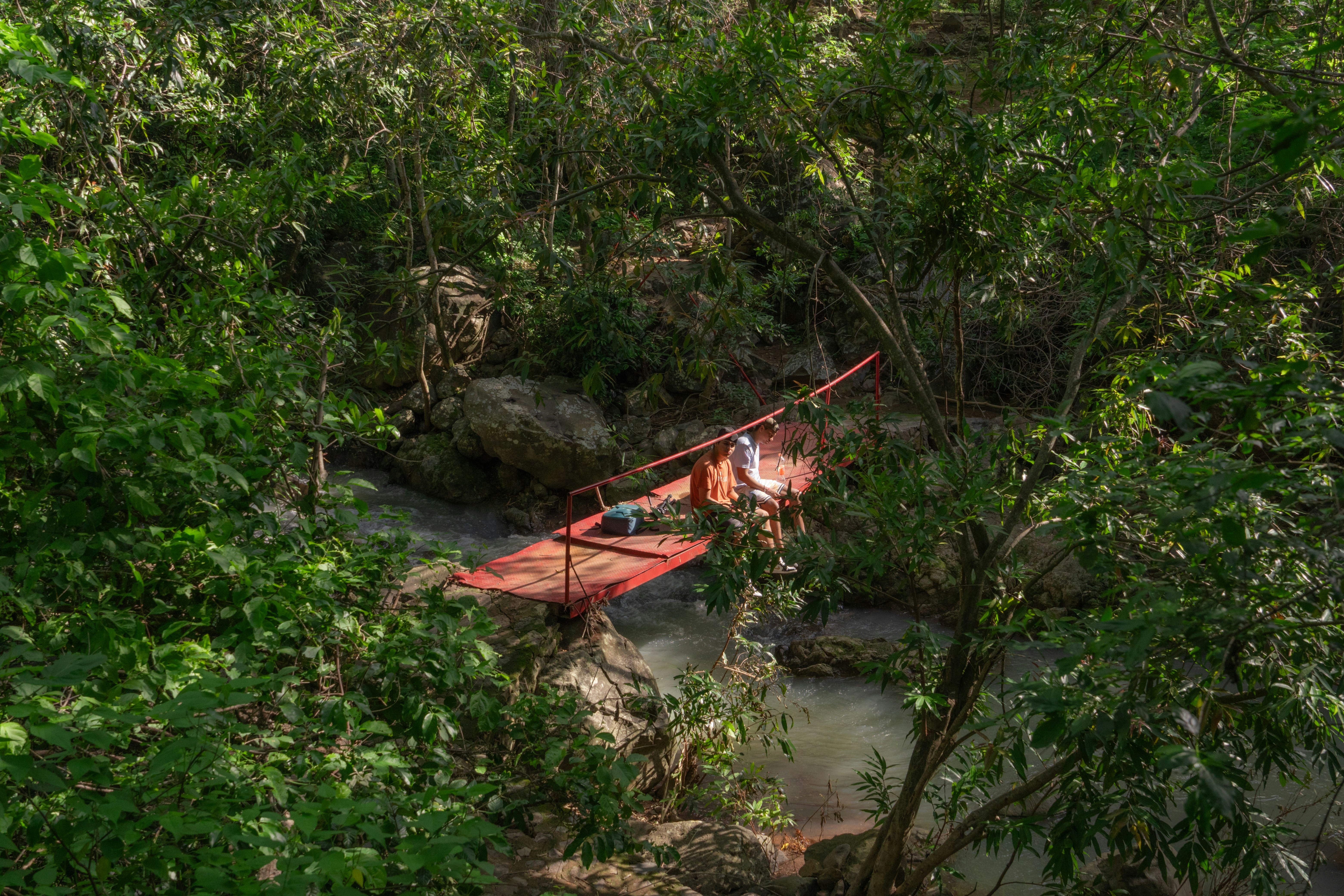 friends | A person on a raft navigating a shallow river.