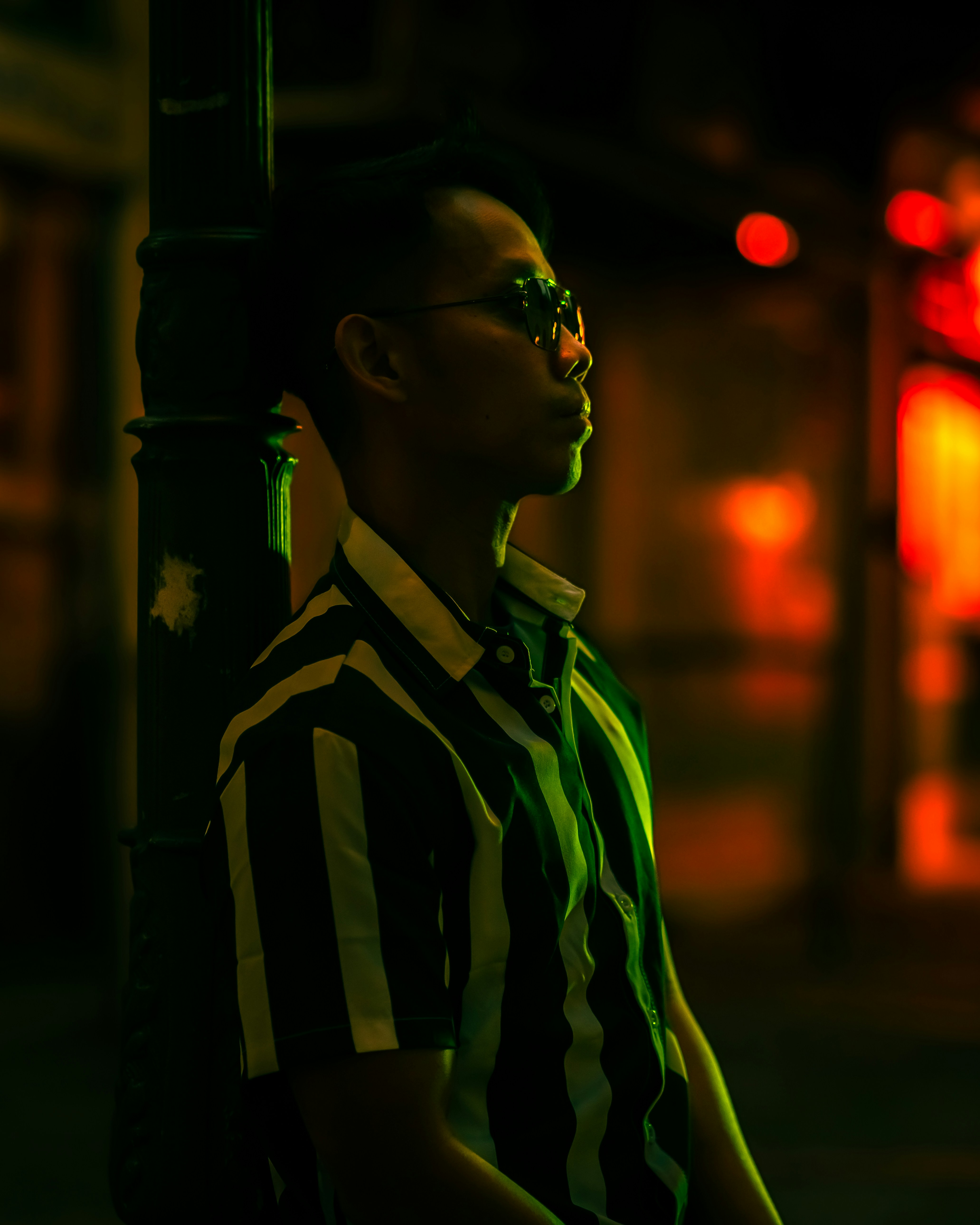 Neon Quiet at the Corner: A Night Portrait in Green and Red Reflections