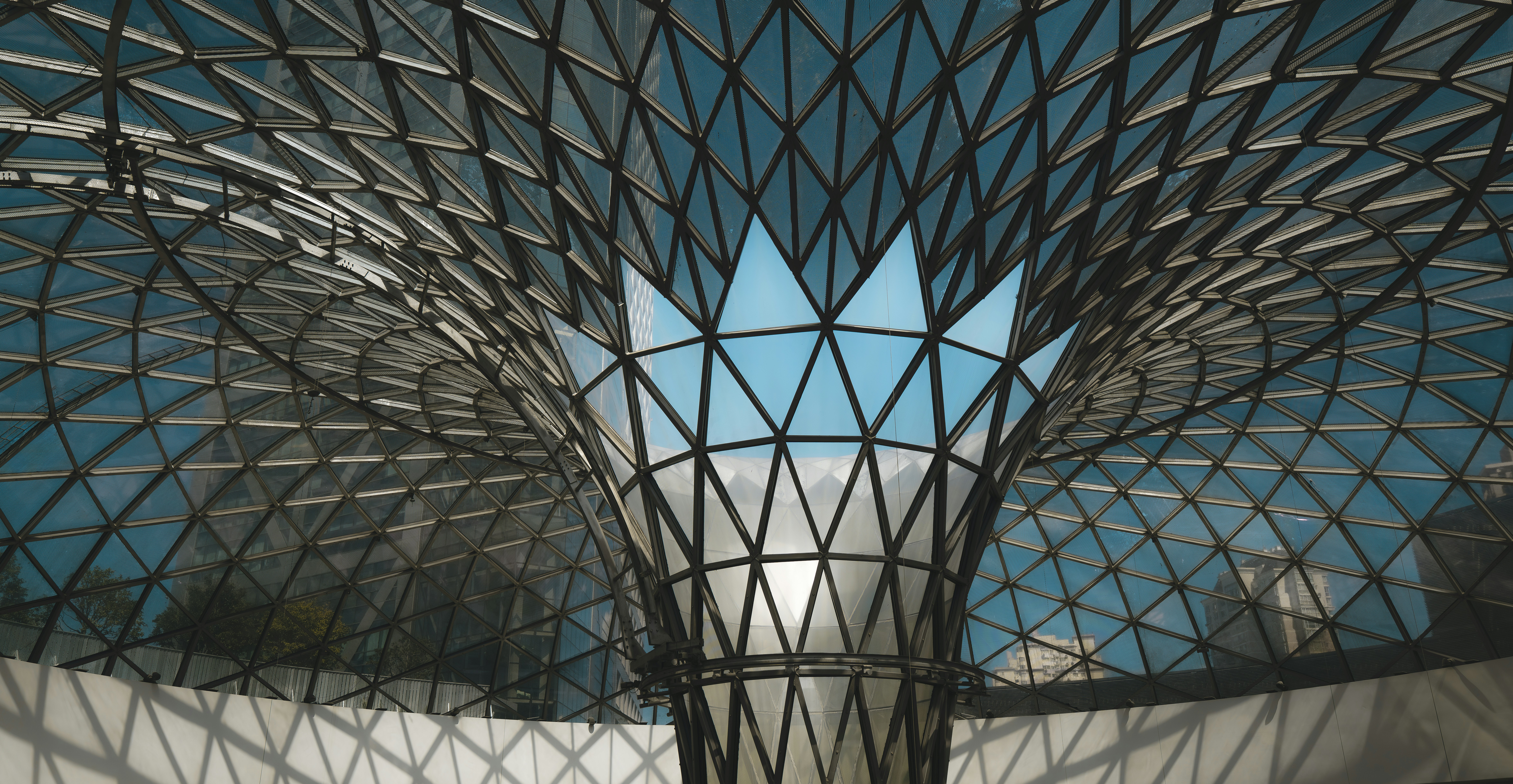 Modern glass ceiling structure with geometric patterns