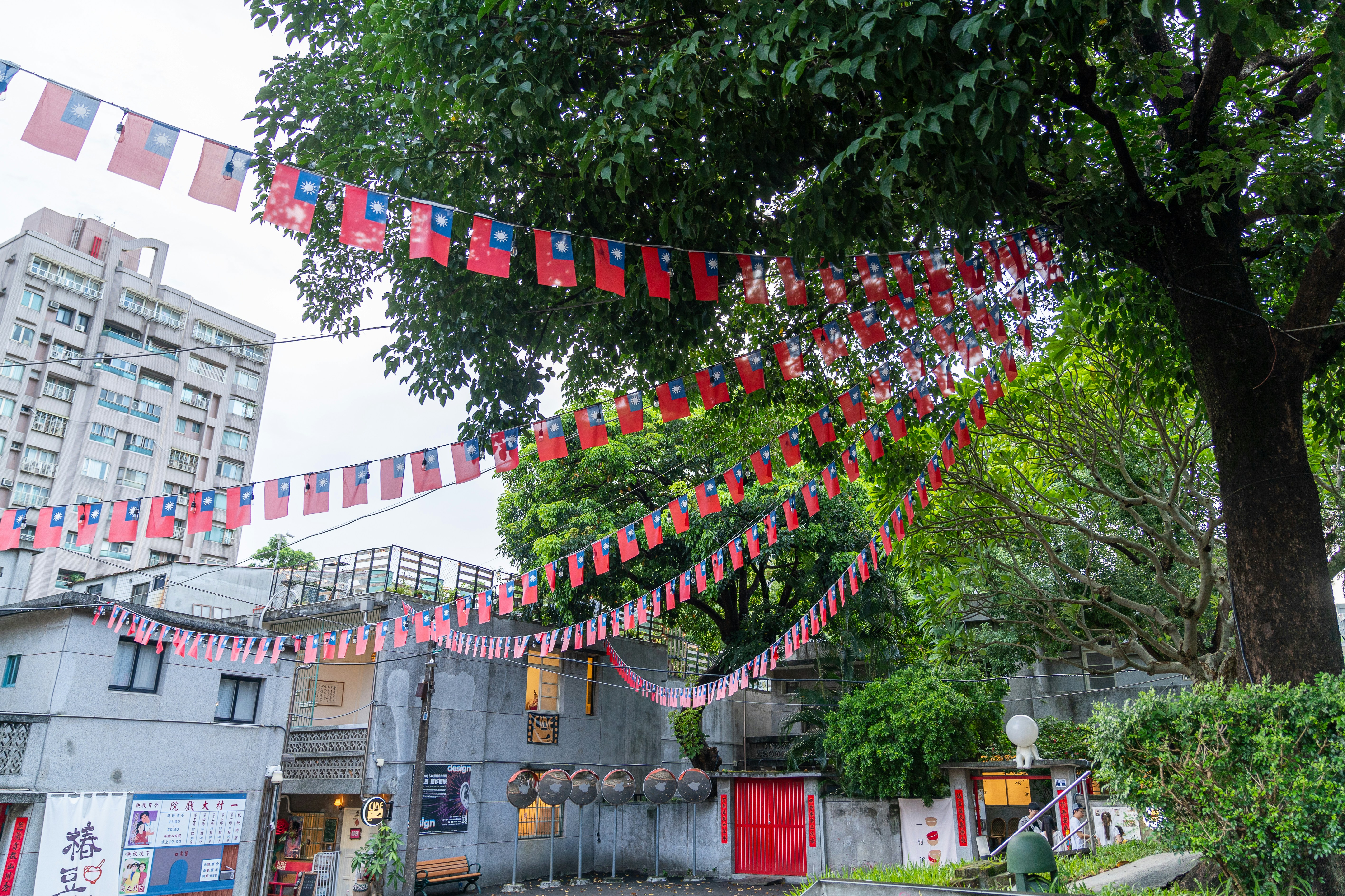 Taiwanese flags strung between trees and buildings.