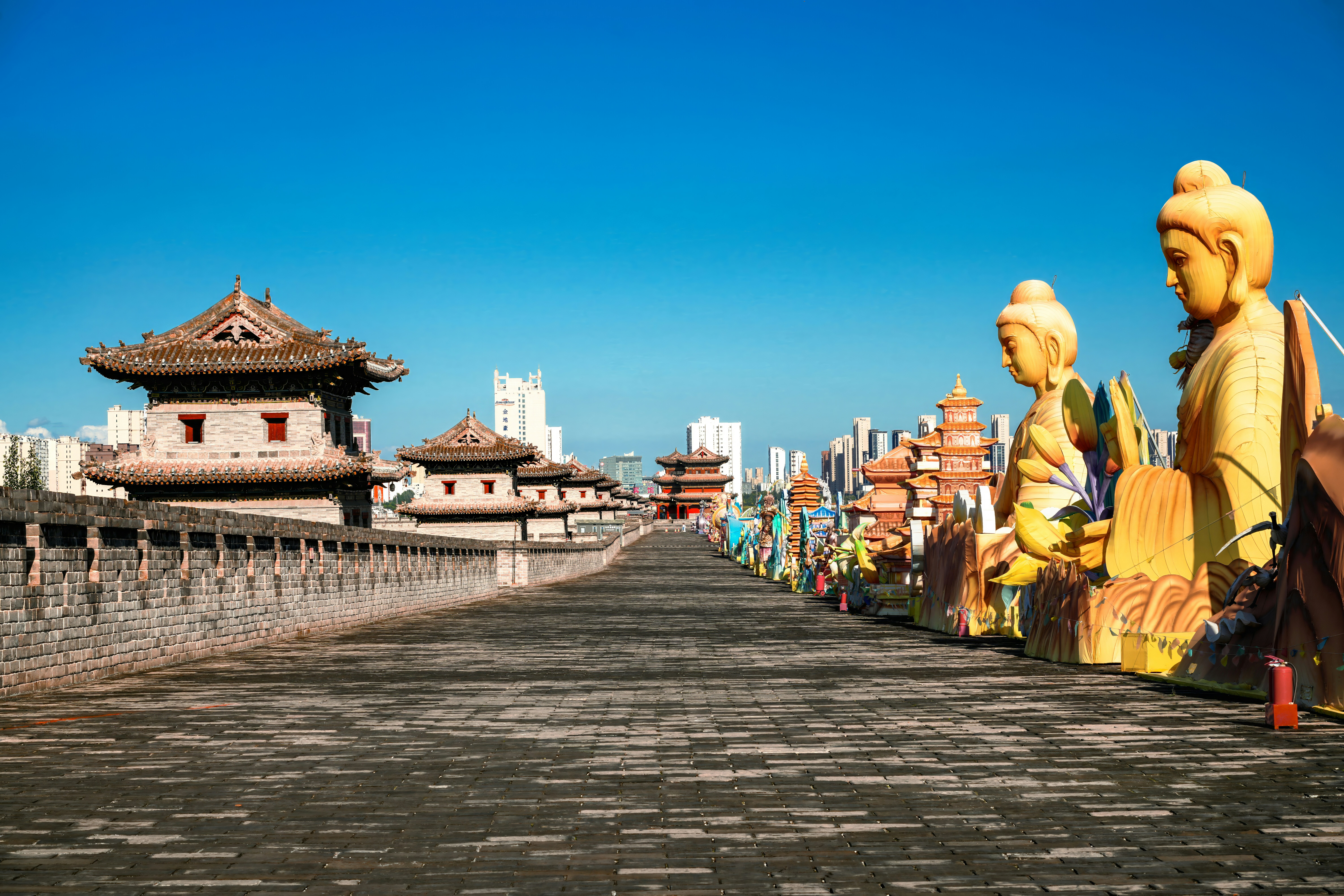 Ancient chinese architecture with large statues under blue sky