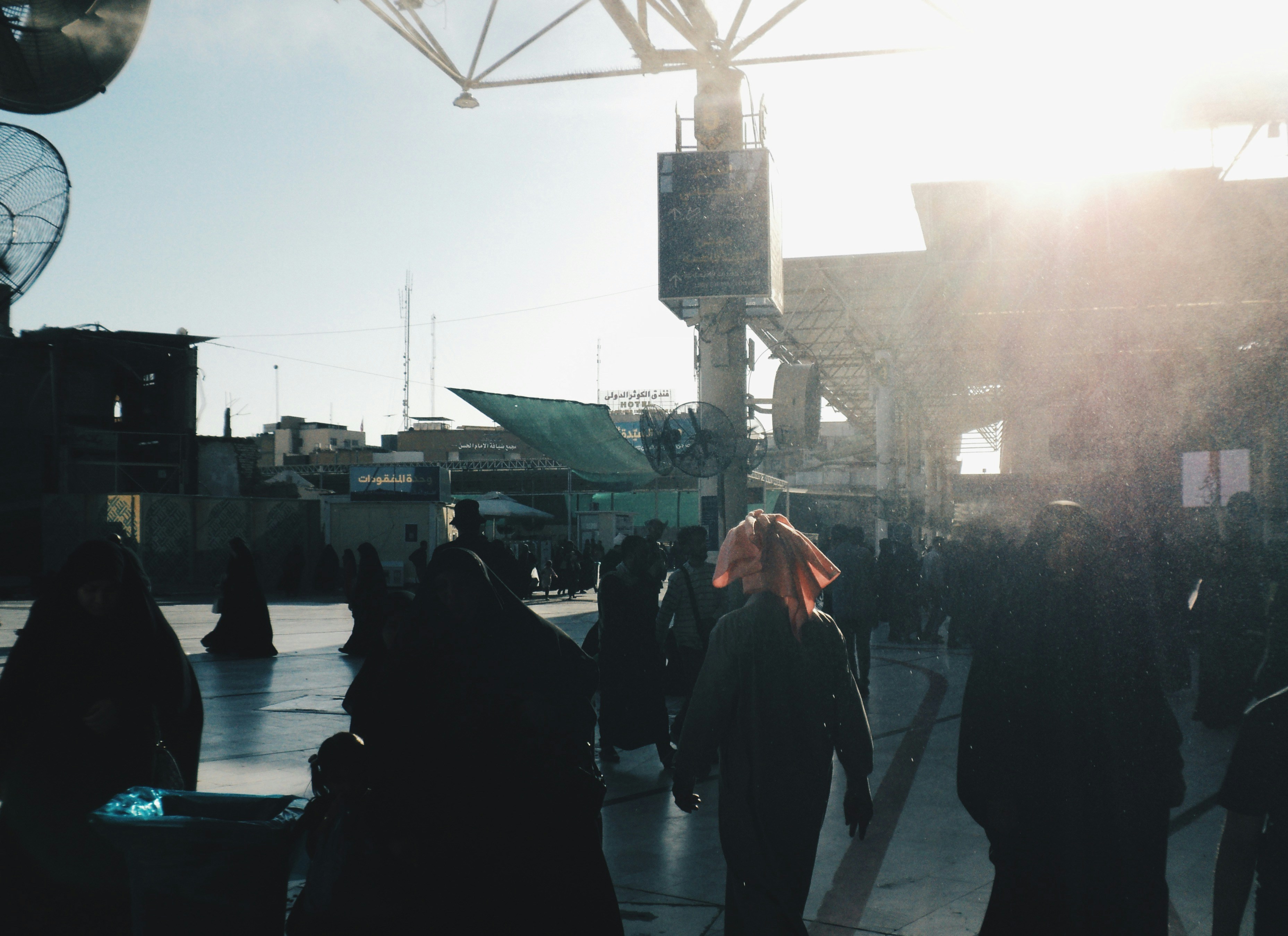Sunlit Silhouettes in a Busy Plaza