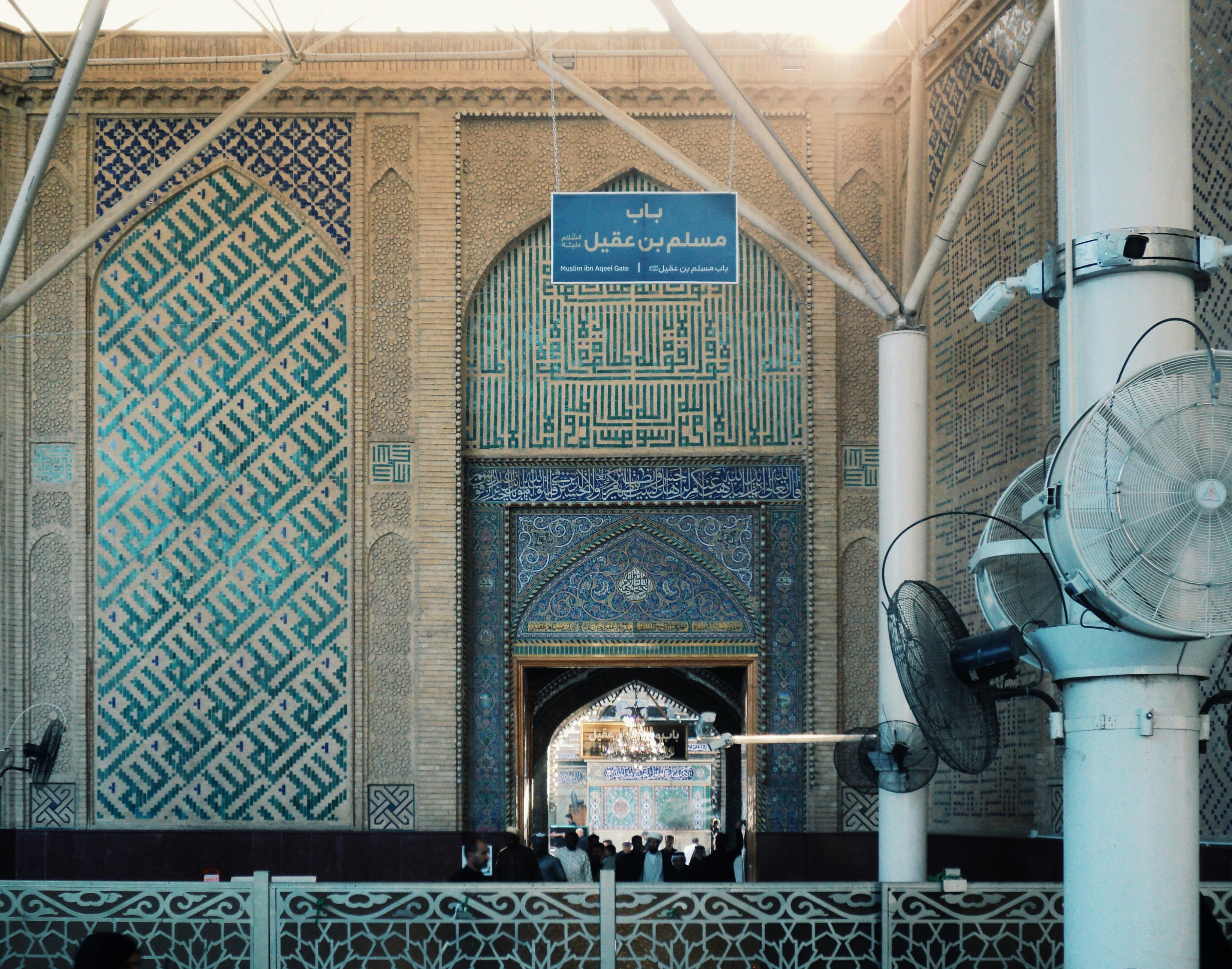 Where a gate is a masterpiece of light and faith. | Ornate entrance to a building with arabic calligraphy
