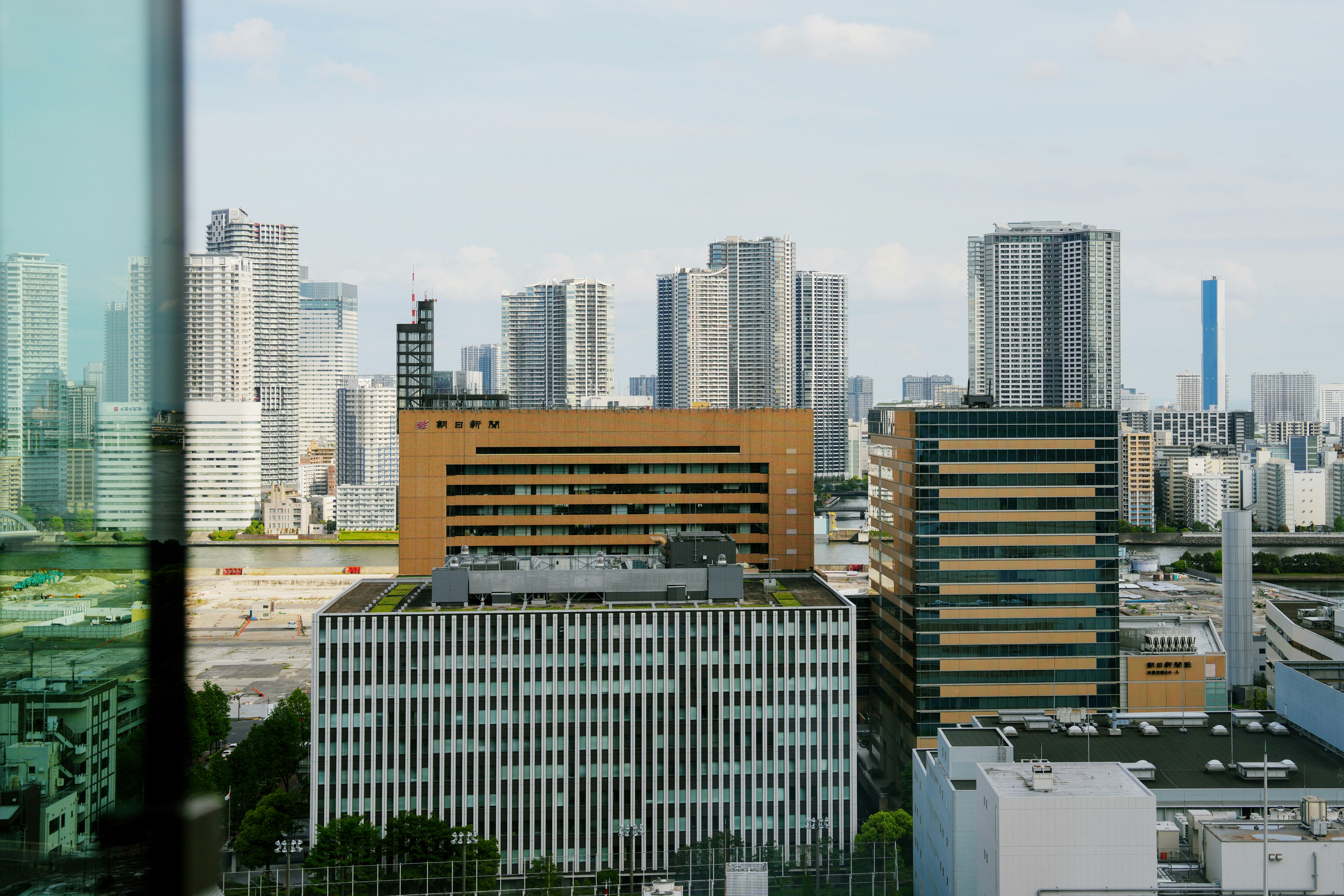 Modern city skyline with tall buildings under a clear sky.