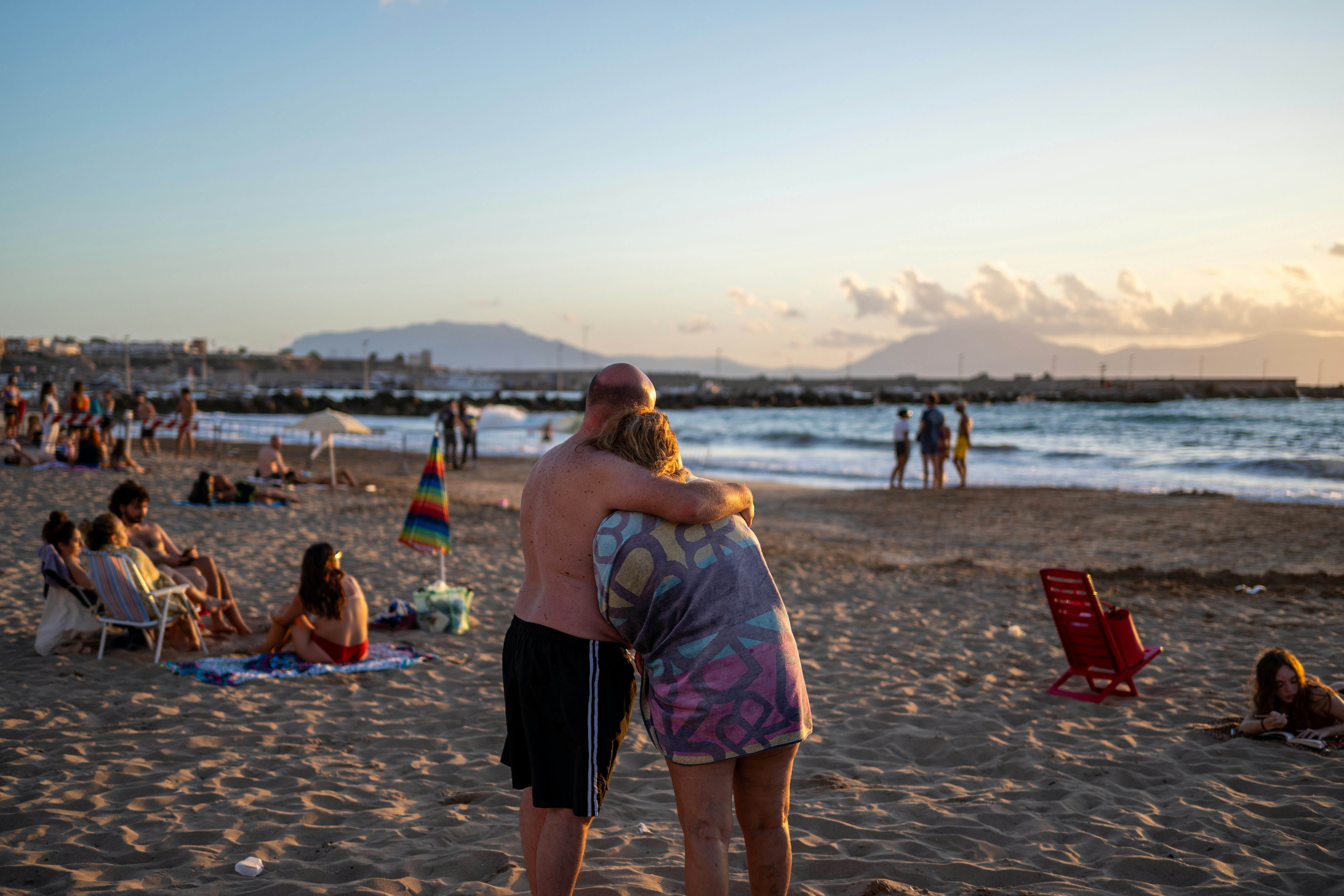 Couple embracing on a beach at sunset