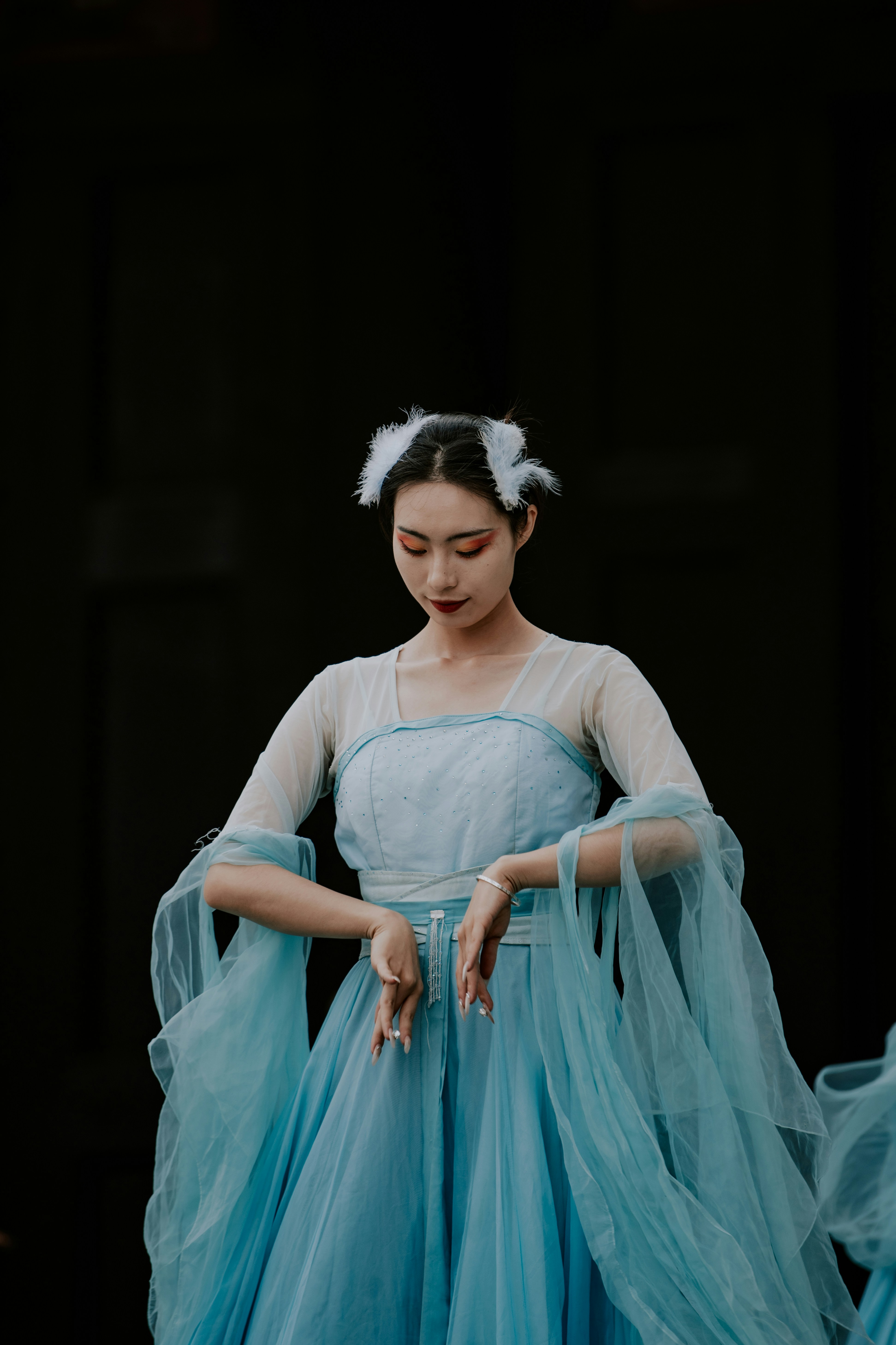 A woman in a light blue traditional dress dances photo – Free Portrait ...