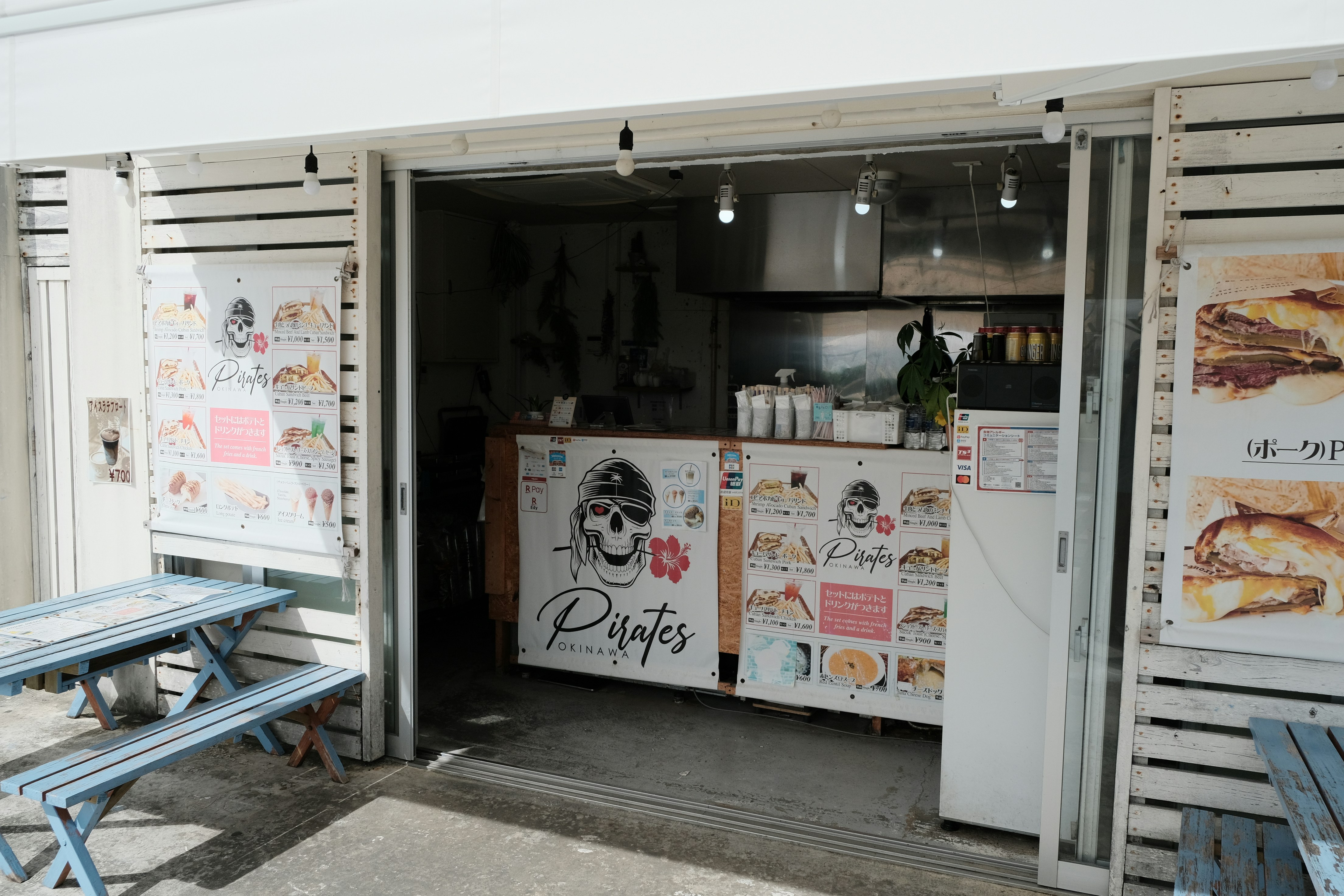 Pirates at the Window: A Weathered Takeout Stand Framed by Slatted Walls