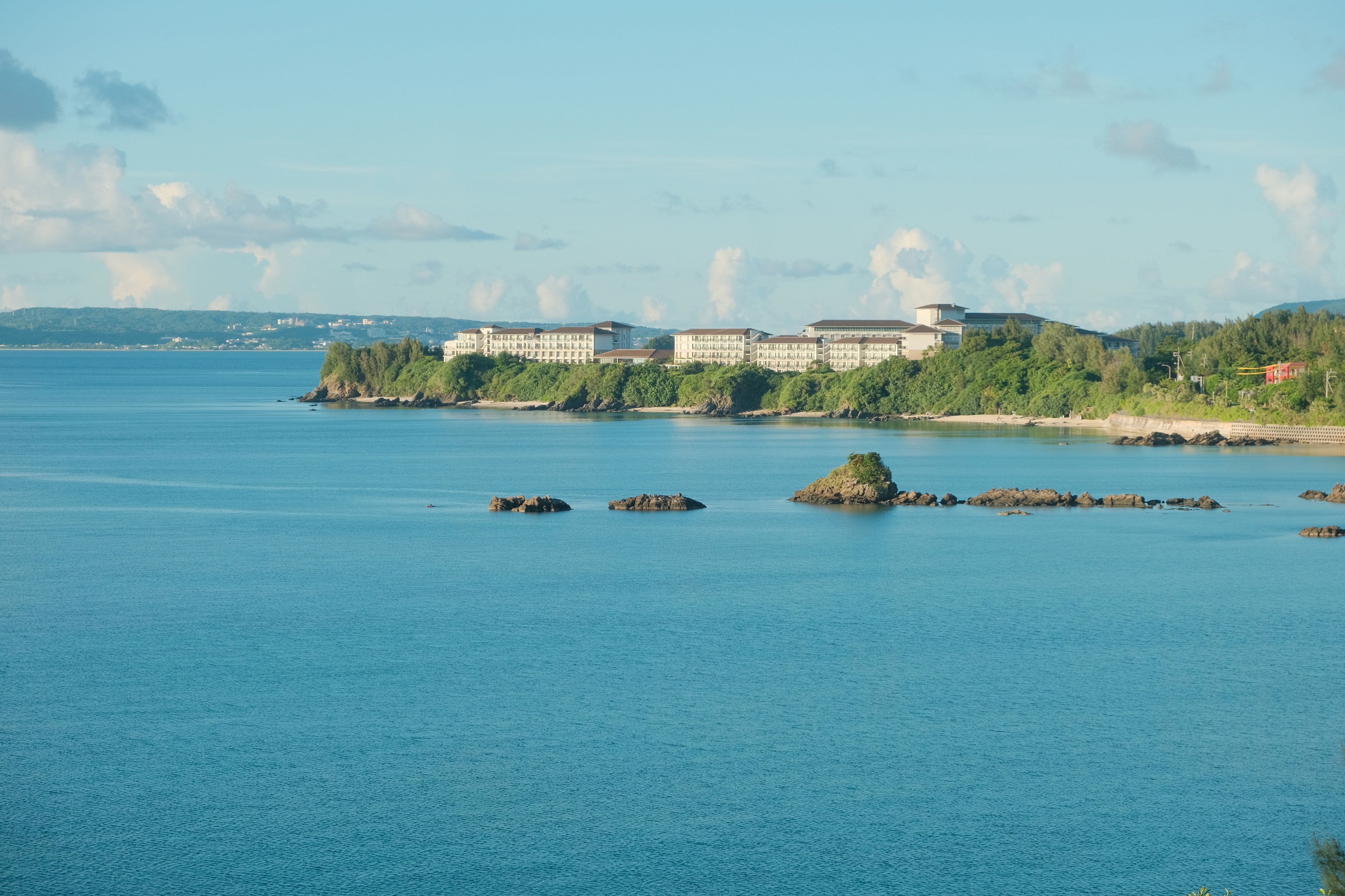 Buildings on a coastal cliff overlooking the ocean.