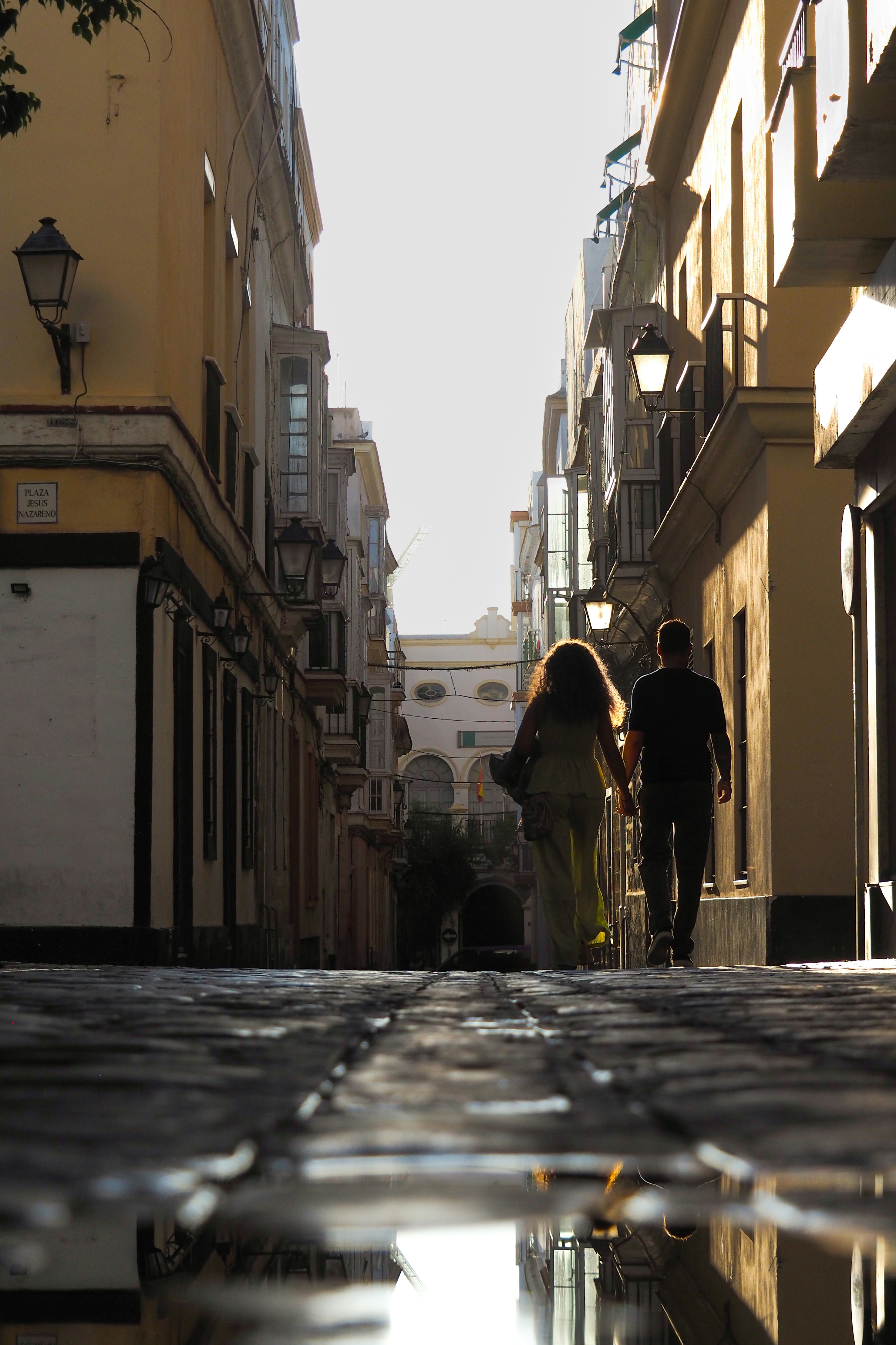 Evening walk in Spain ✨️ | Couple holding hands walking down cobblestone street