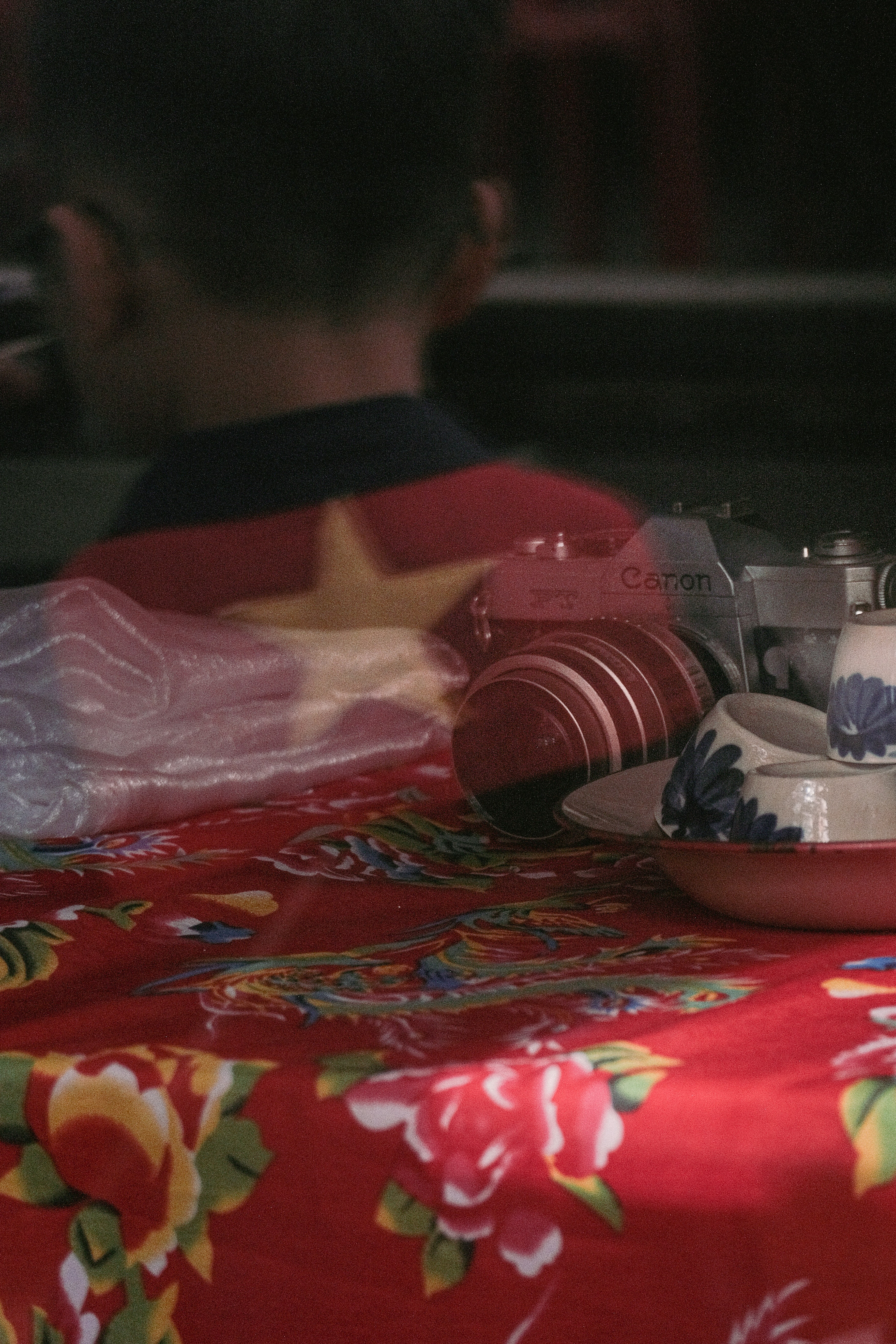 Child wearing a red shirt with a star, seated at a table.