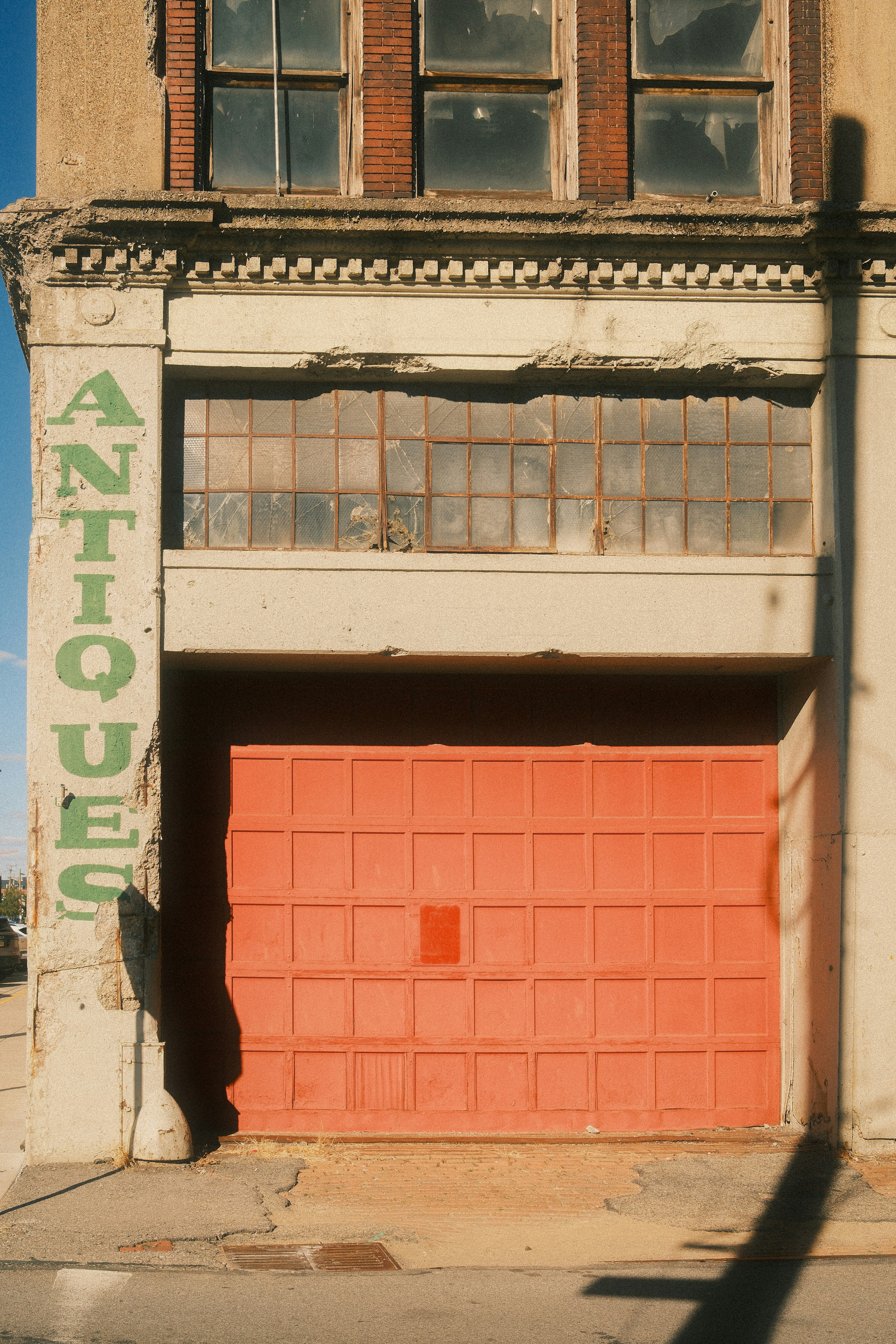 Orange Portal on a Sunlit Antique Façade