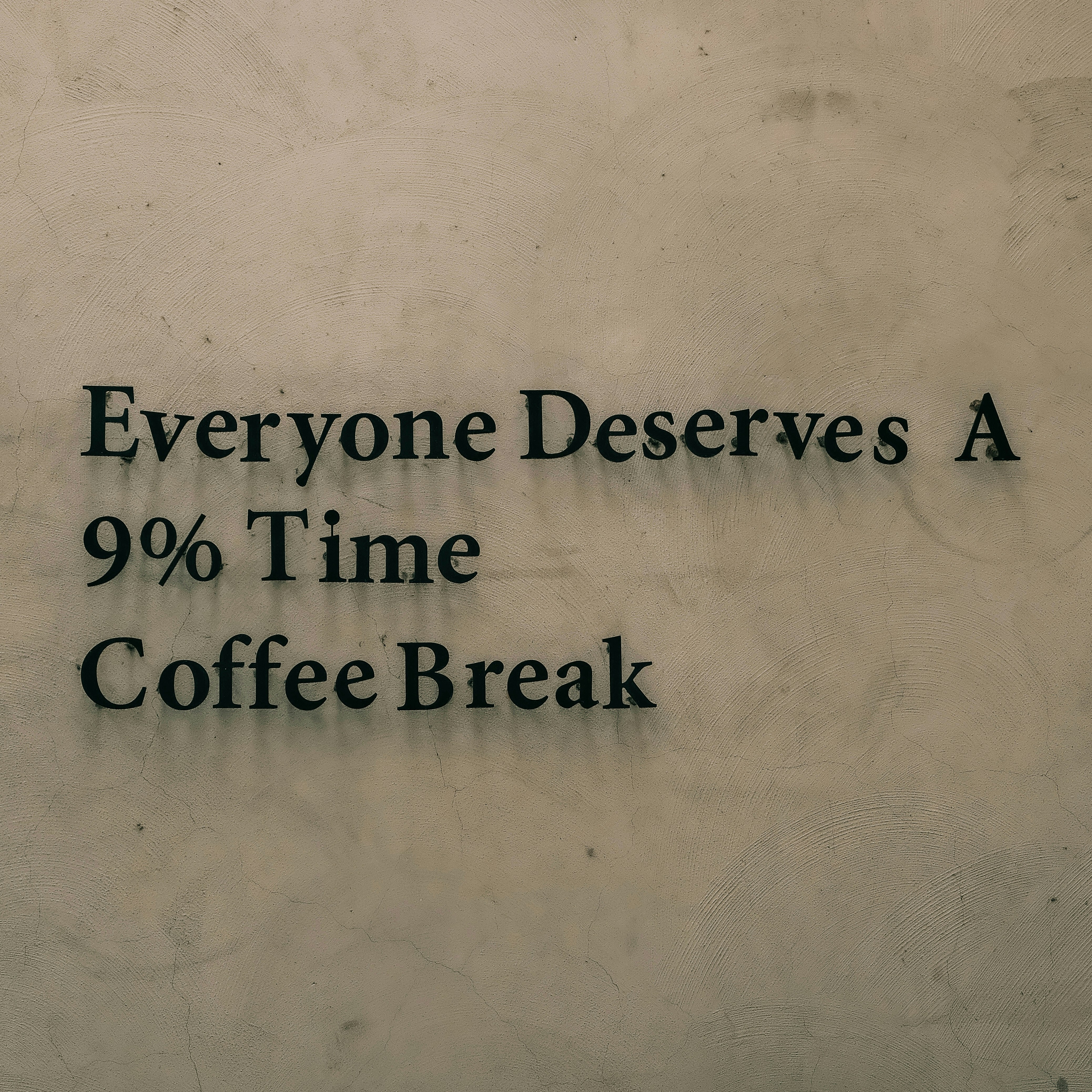 Text on wall reads: everyone deserves a coffee break