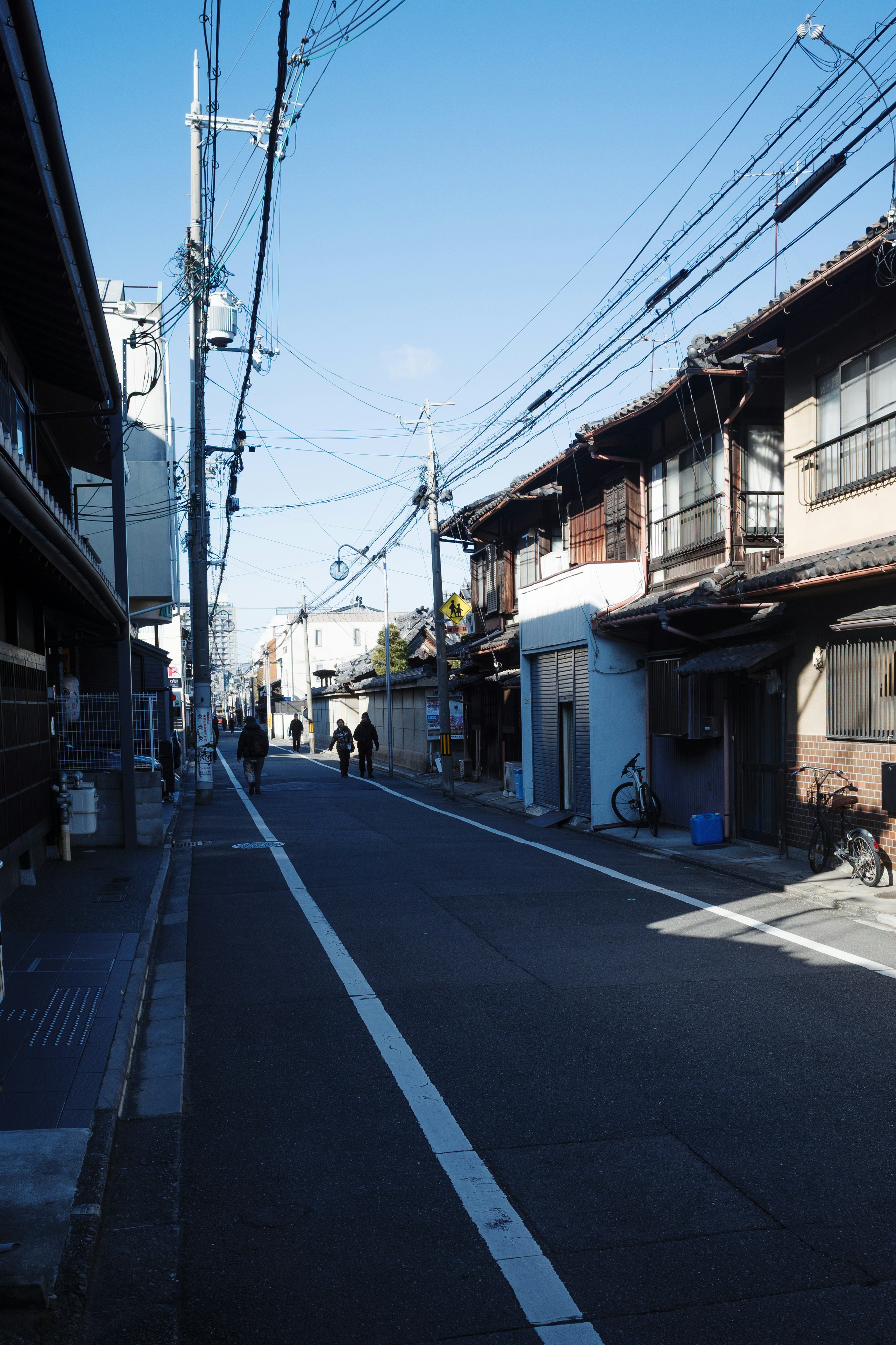 Street with traditional japanese houses and overhead wires