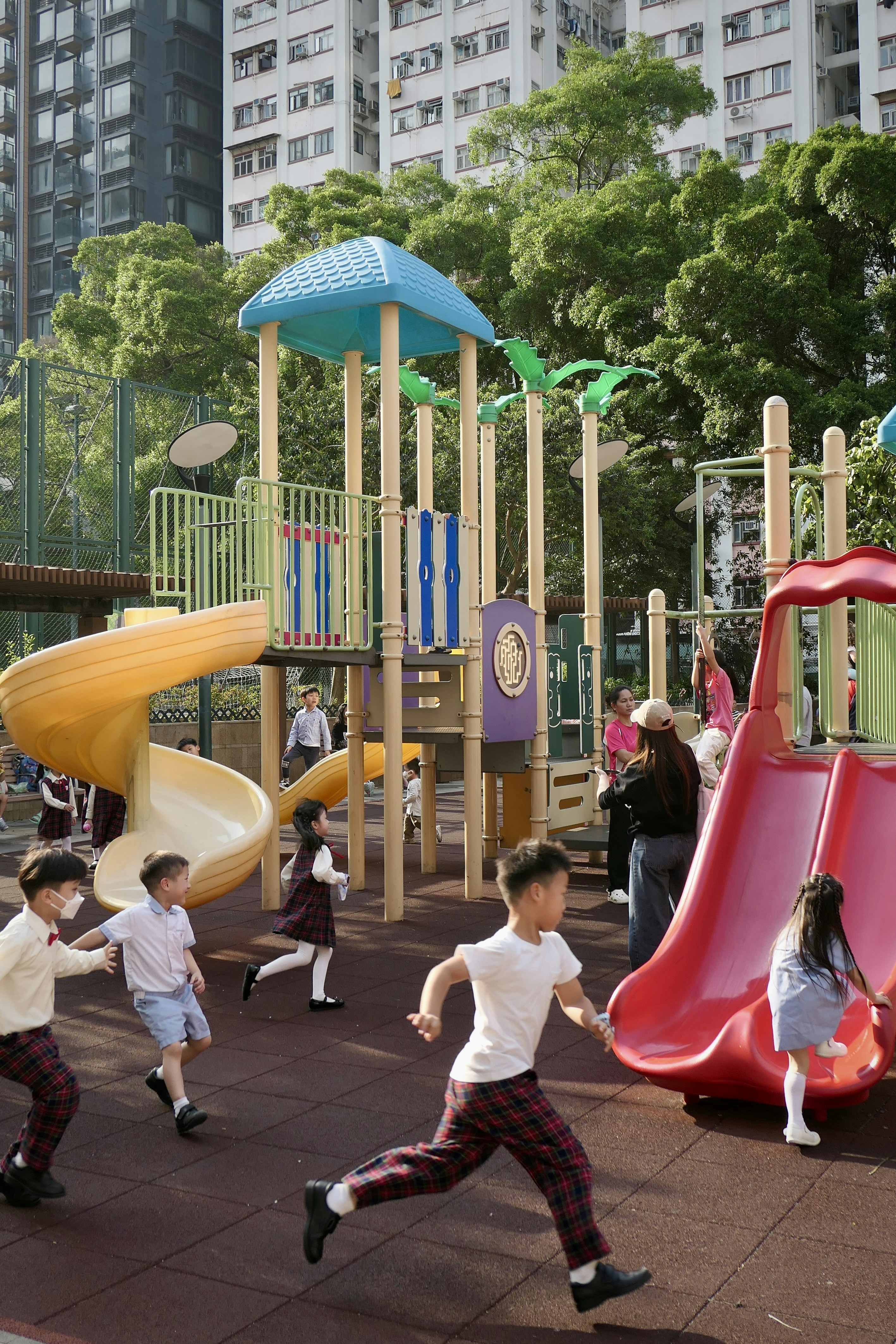 Children playing on a colorful playground with slides