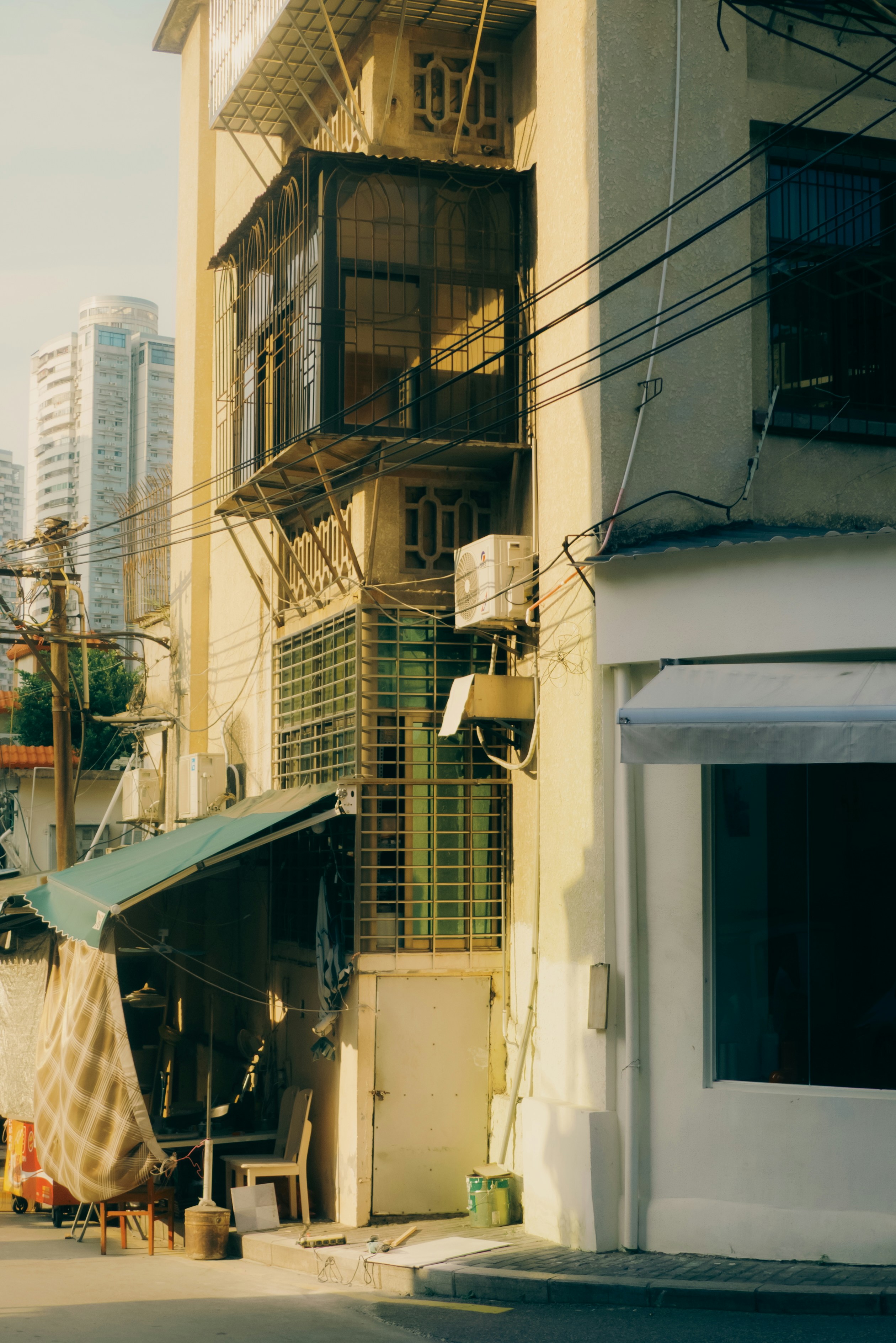 Old building with wires against modern city skyline
