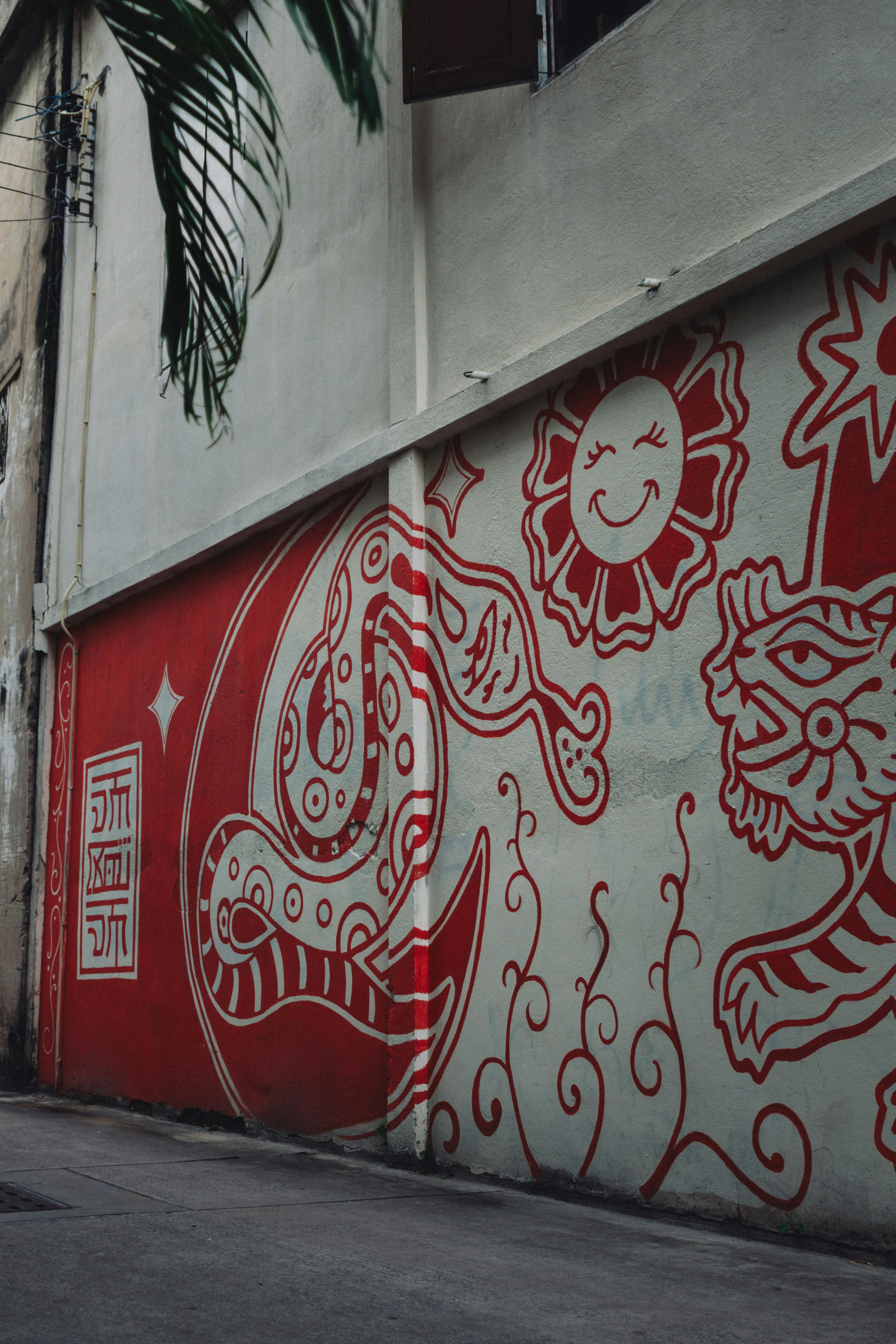 Wall art with moon, sun, and tiger designs.