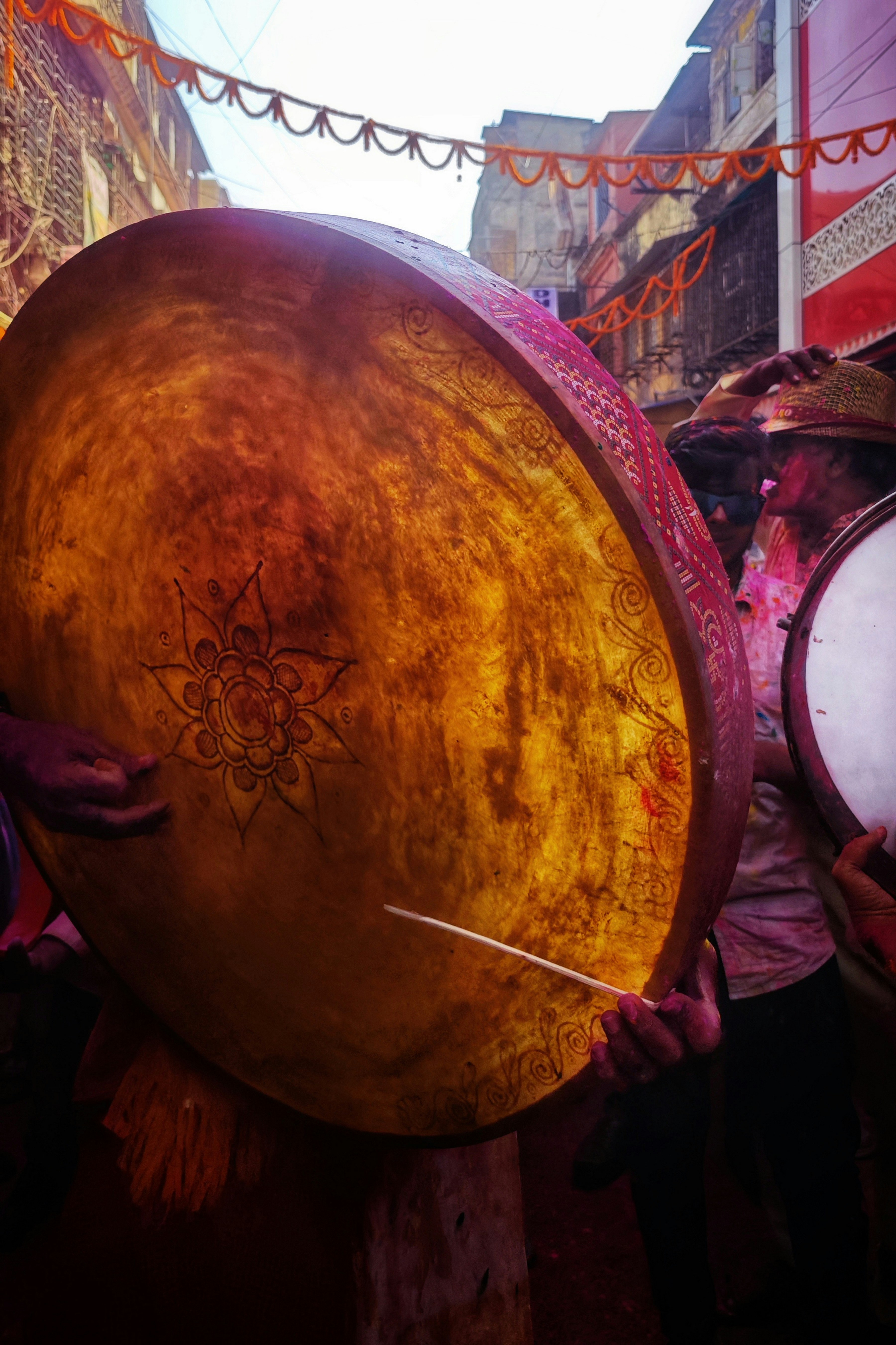 Man playing a large drum during a festival