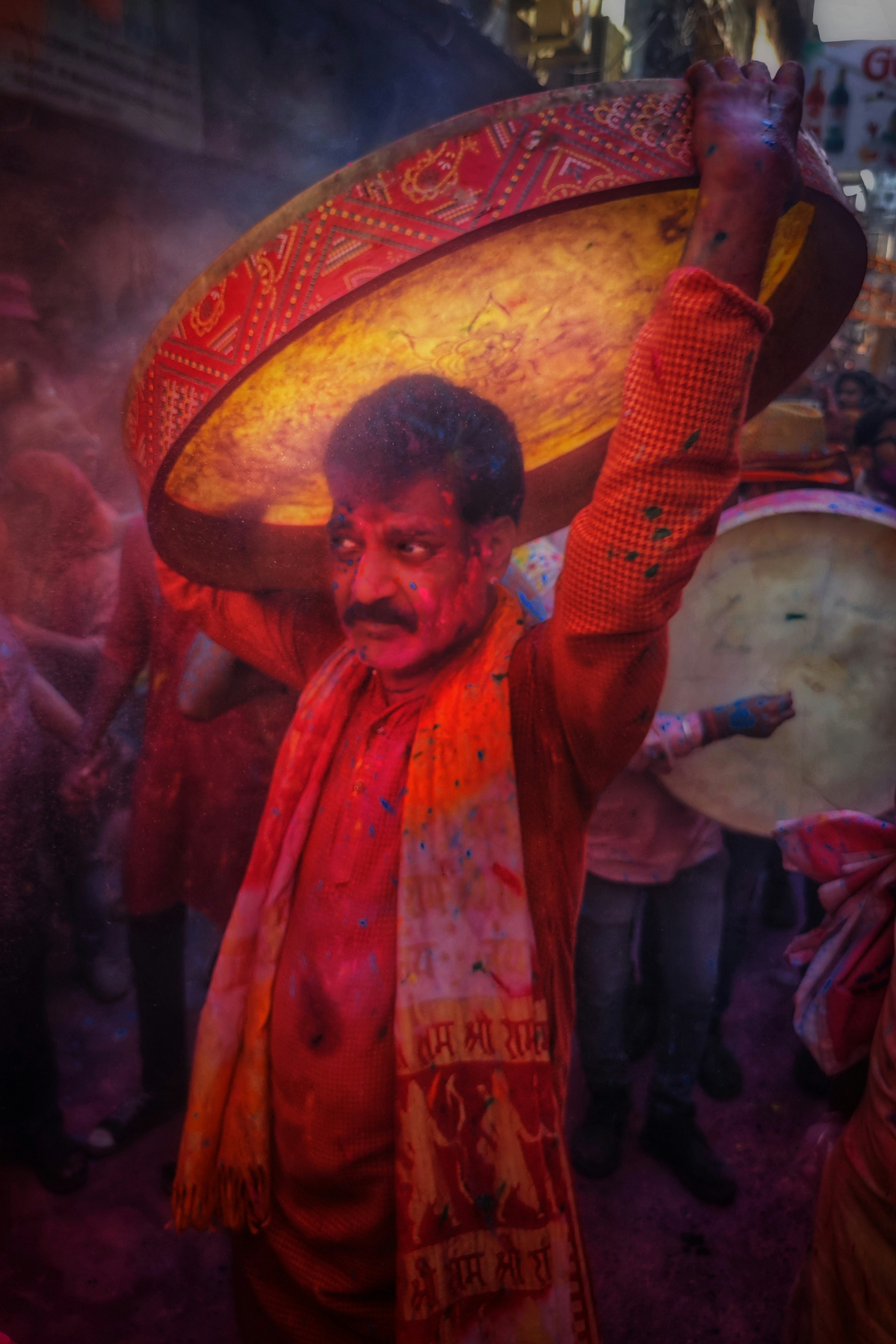 Crimson Dhol: A Vermilion Drum Rises Through Colored Smoke