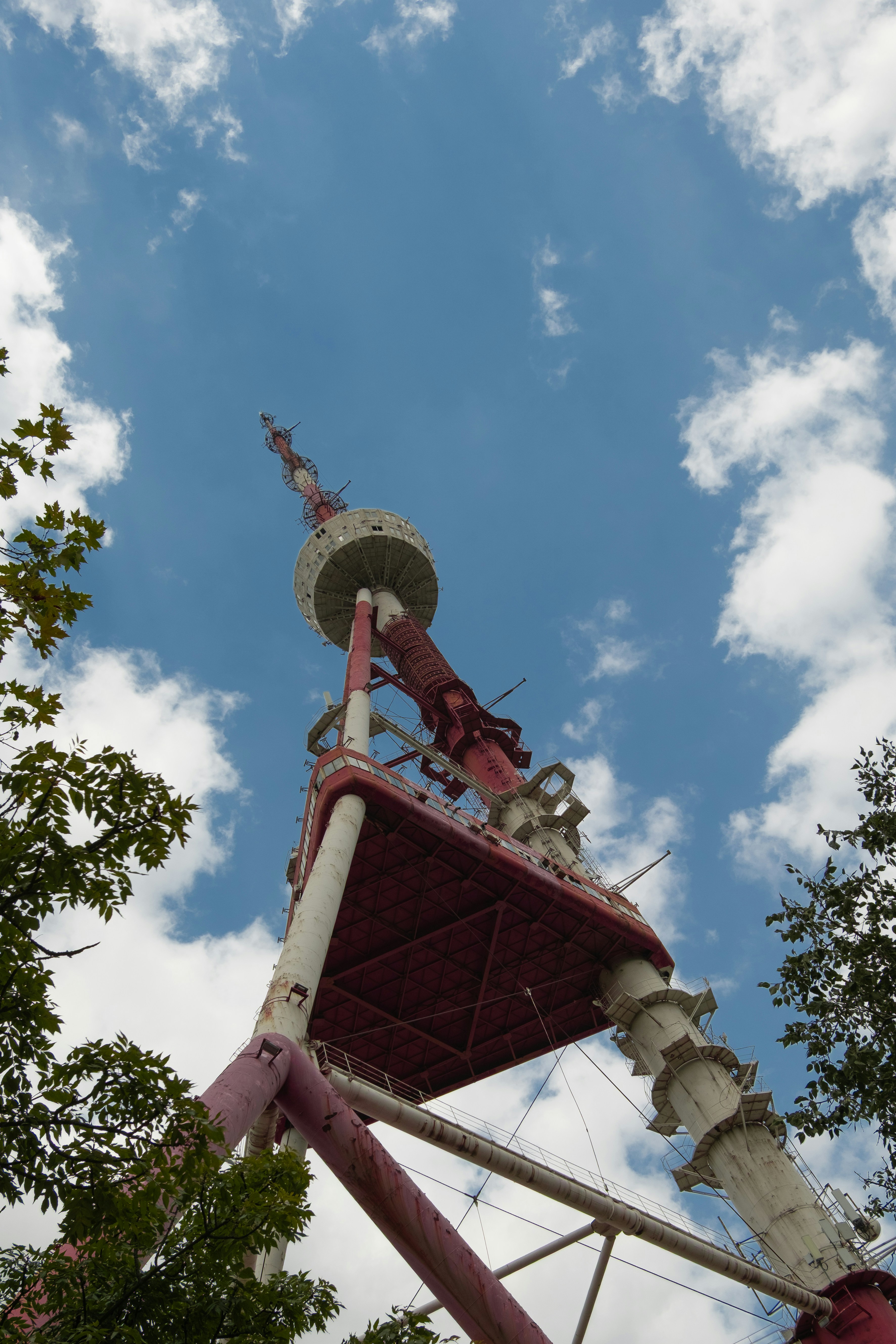 Tall red and white tower against blue sky