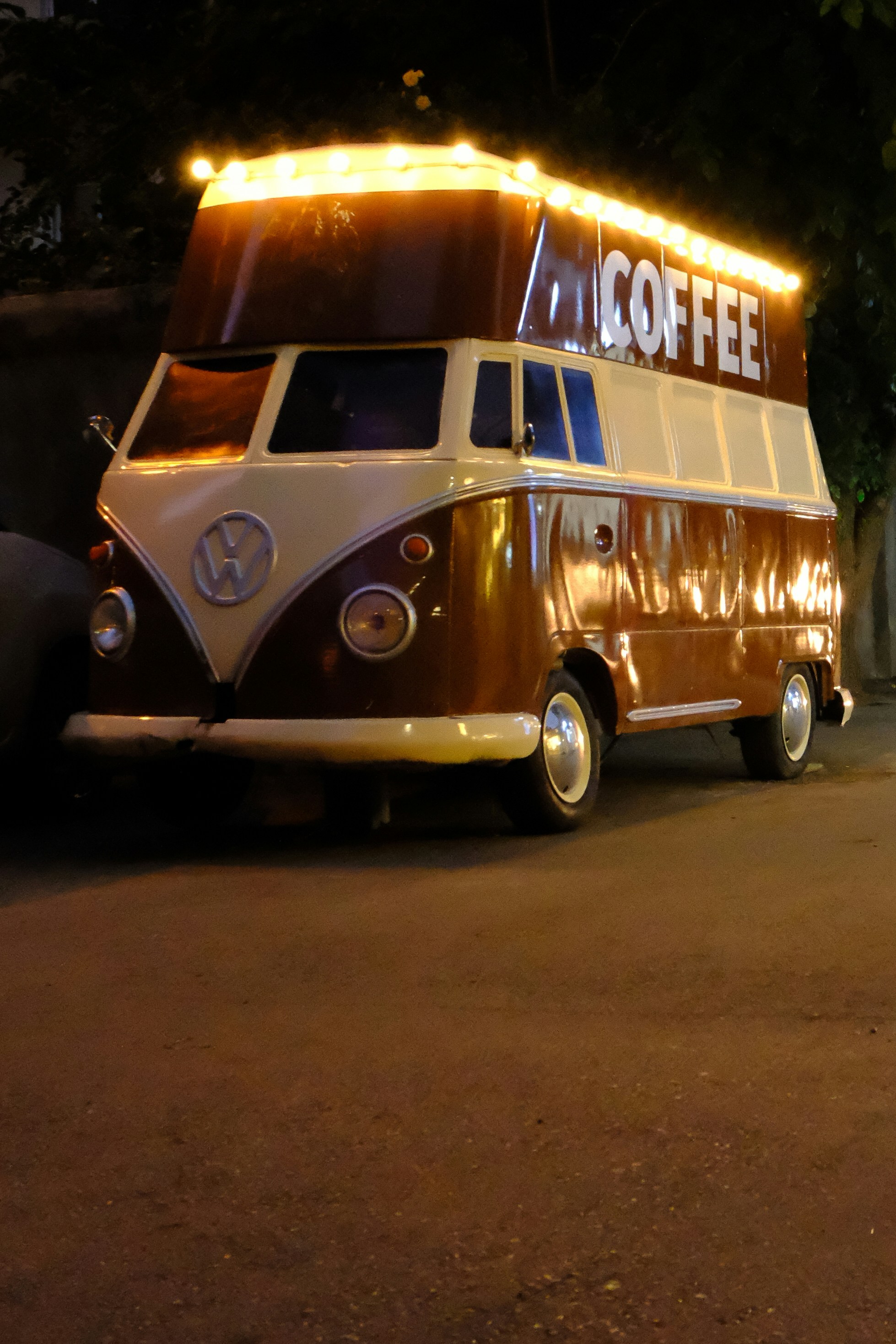 Amber-Glow VW Coffee Bus: A Retro Mobile Café Illuminated by Night Lights