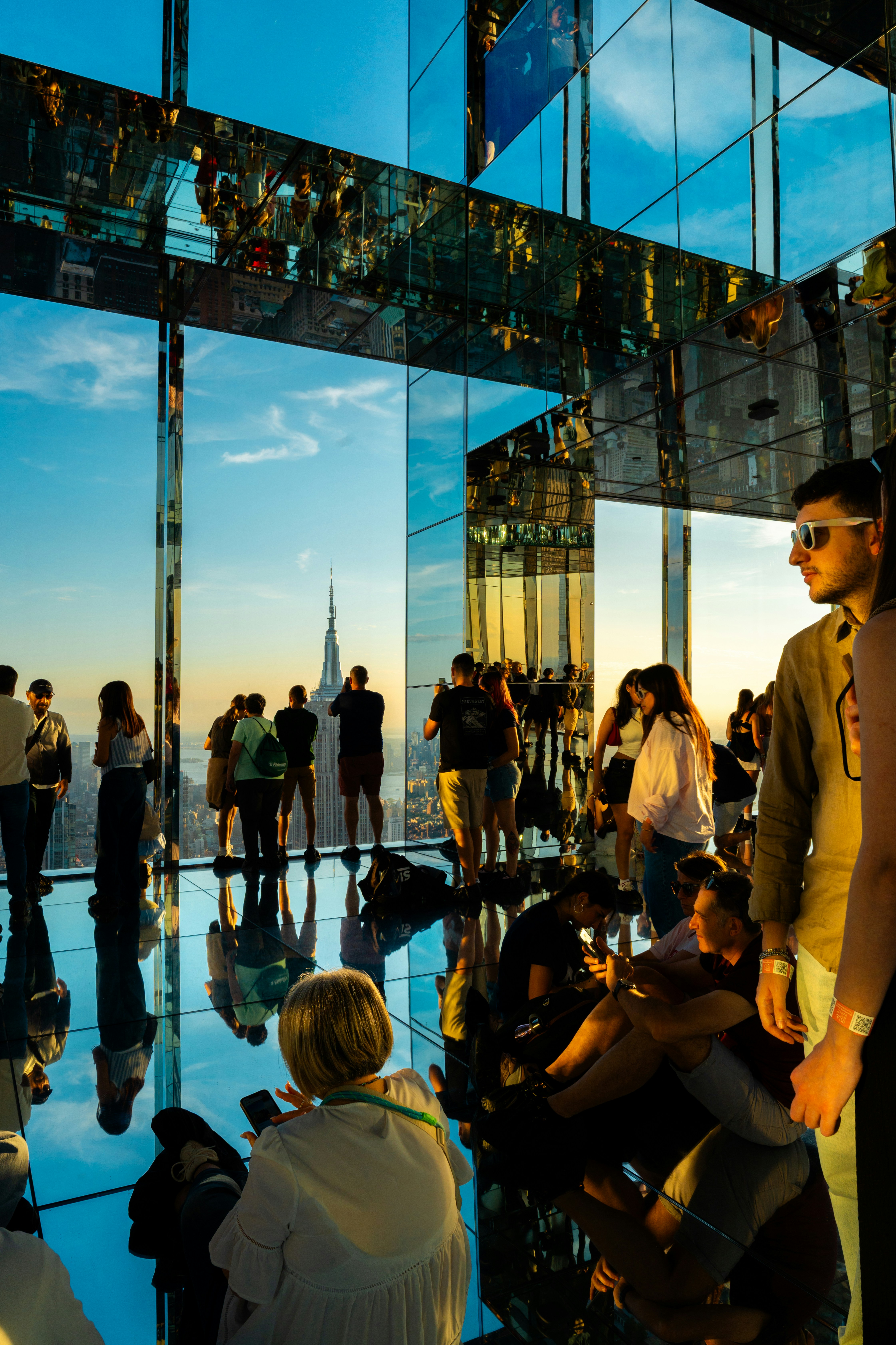 Summit One Vanderbilt, Manhattan, New York. | People admire city skyline through glass walls
