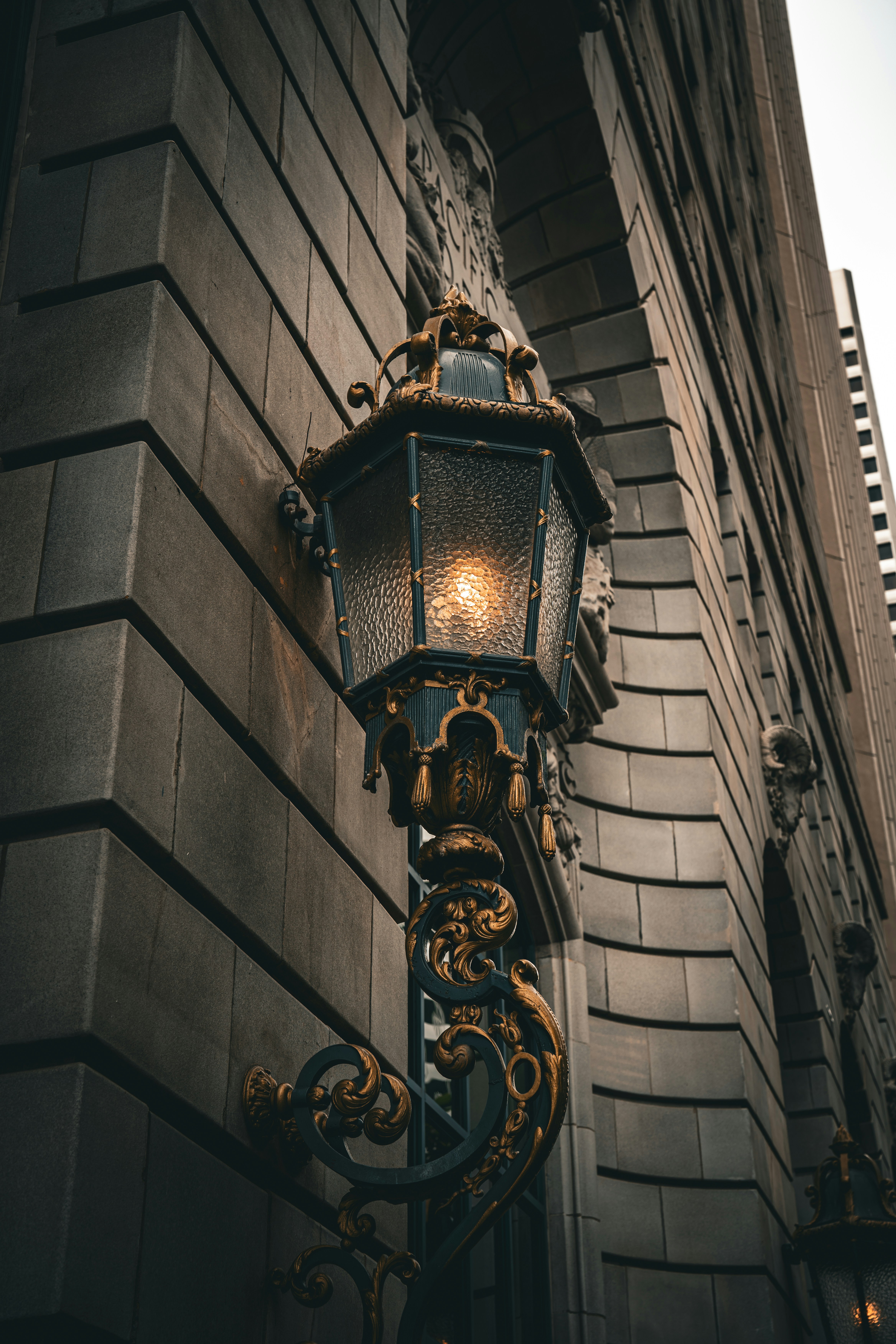 Ornate vintage lantern attached to a stone building