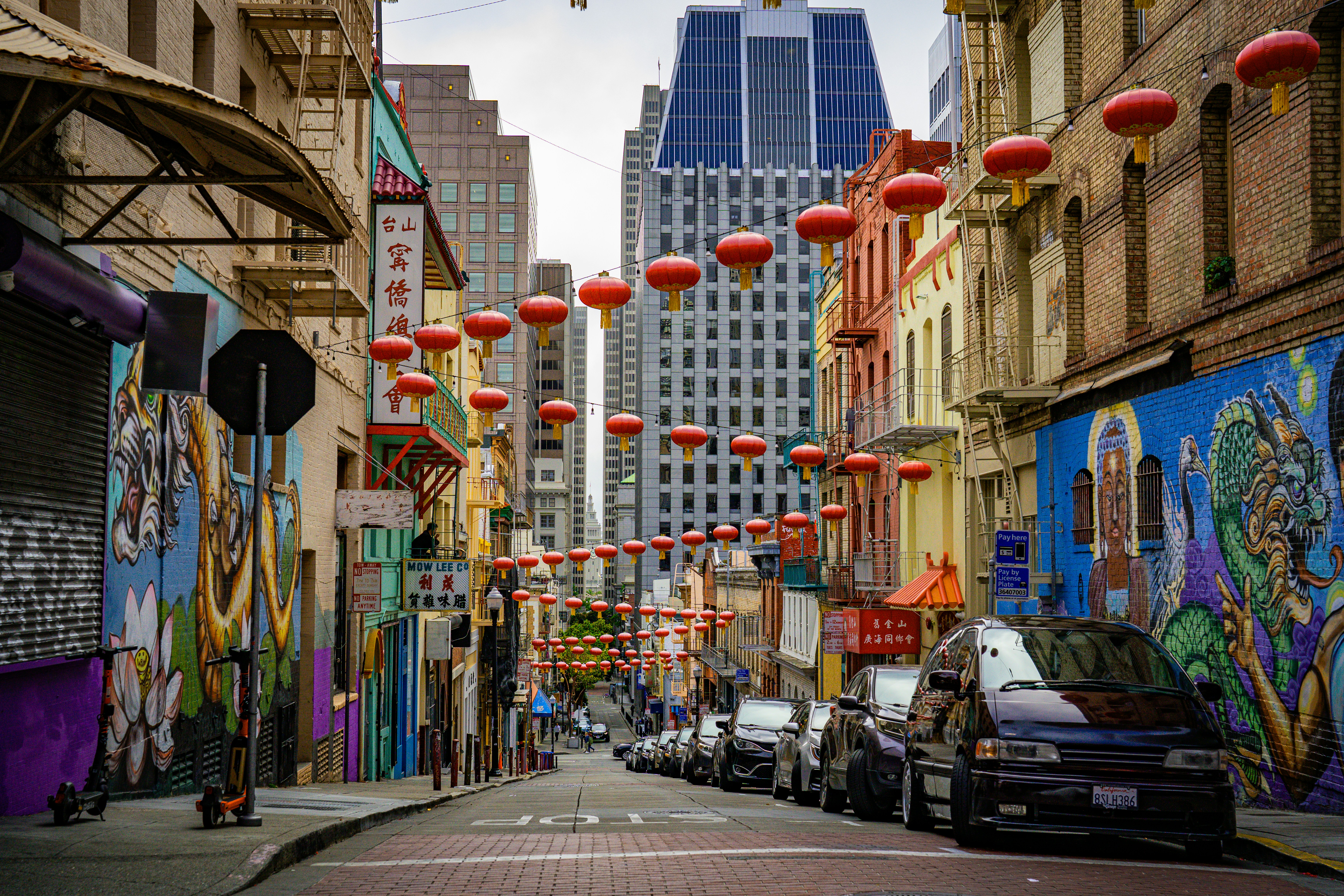 Colorful street in chinatown with red lanterns and murals