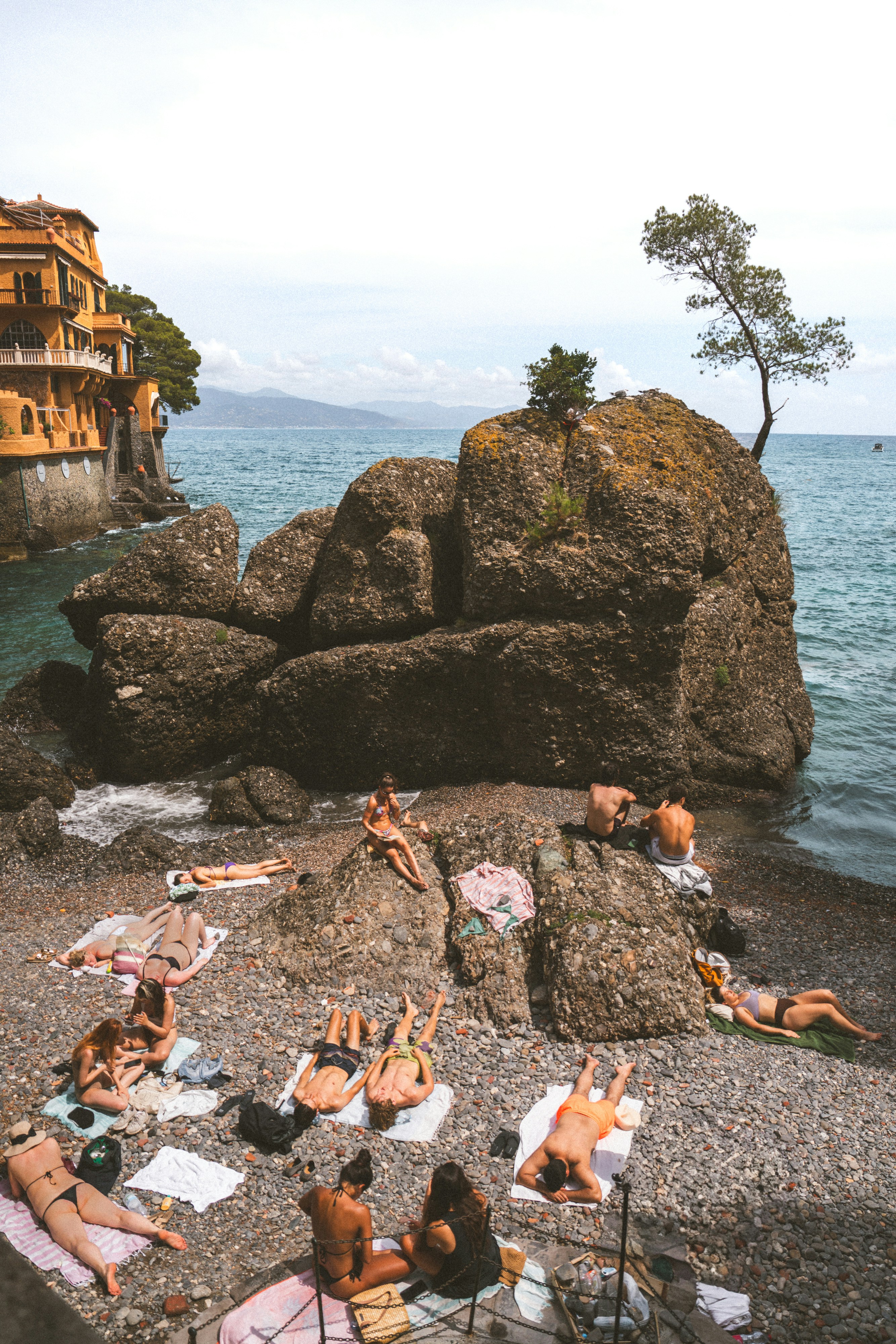 Terracotta Cliffside, Pebble Cove: Sunbathers on a Sea-View Stage