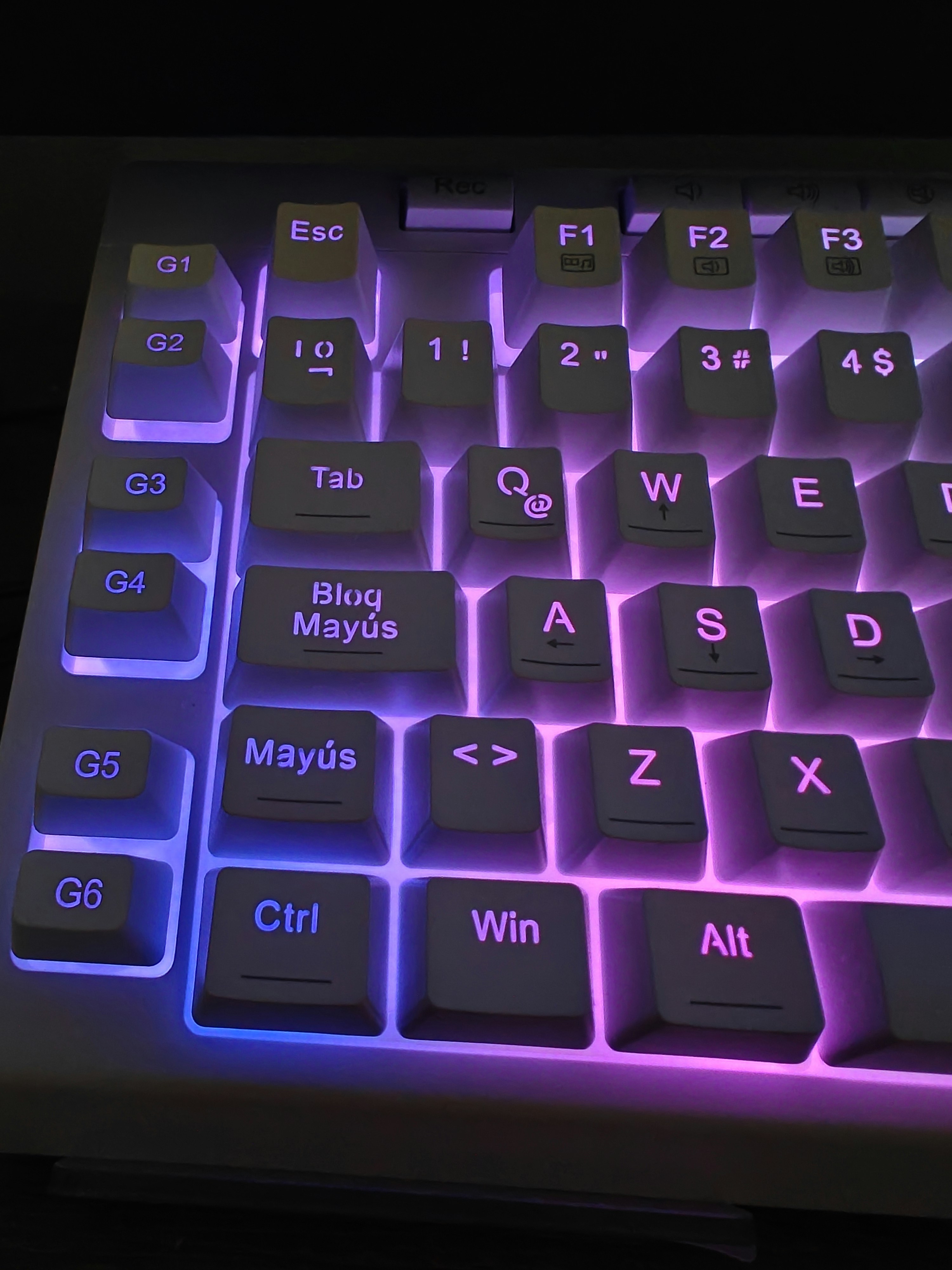 Close-up of a white mechanical keyboard with rgb lighting.