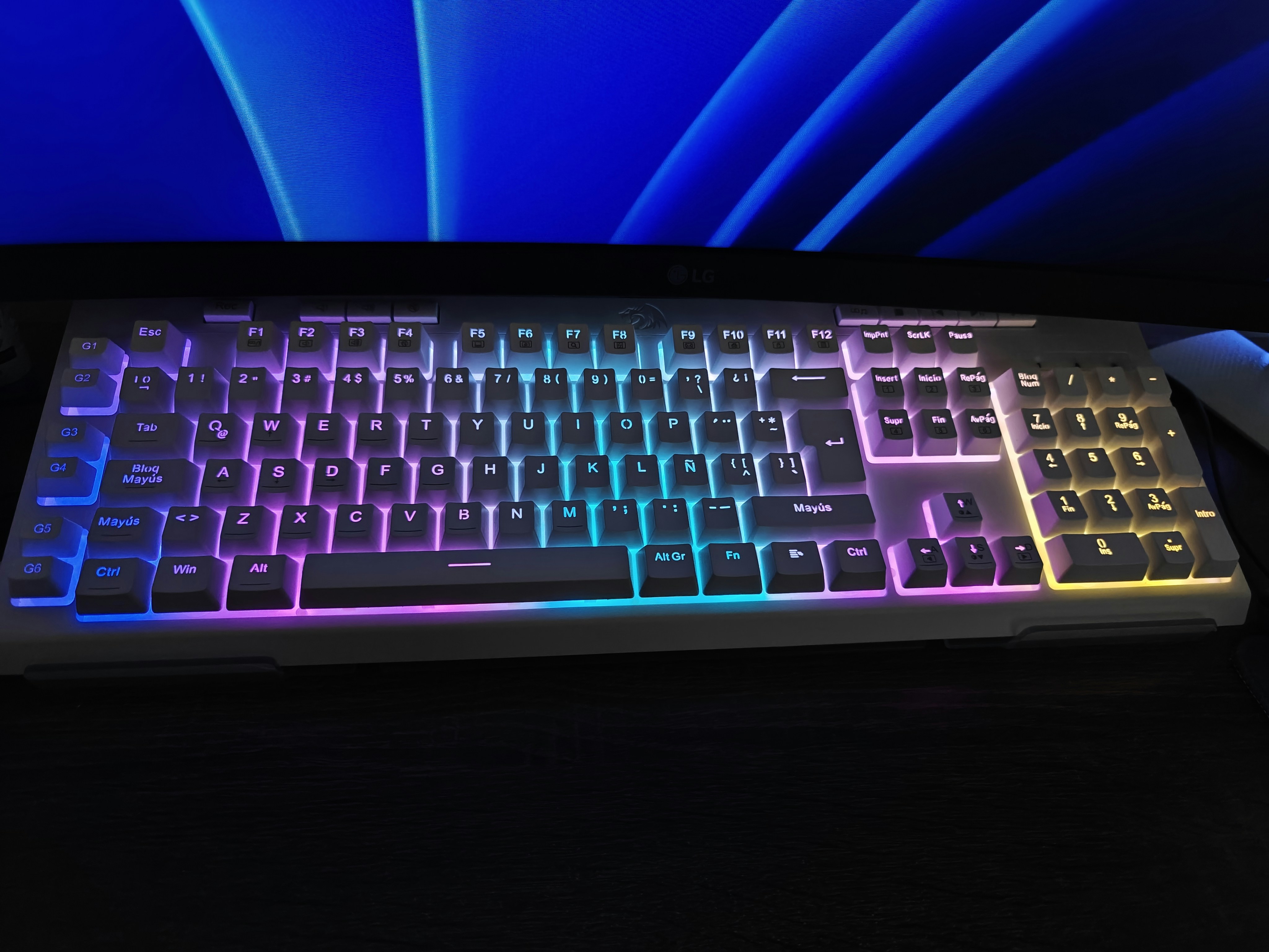 A white keyboard with colorful rgb lighting