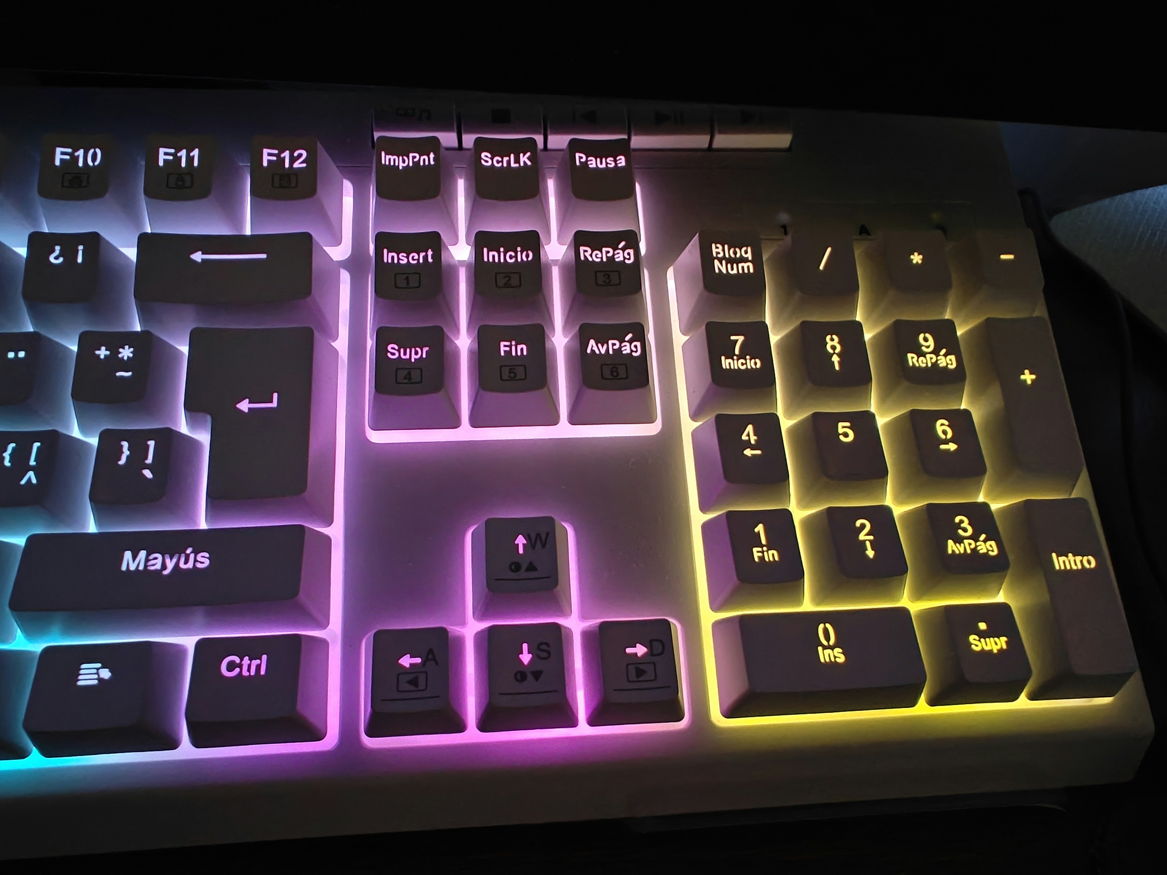 A colorful illuminated computer keyboard with rgb lighting.