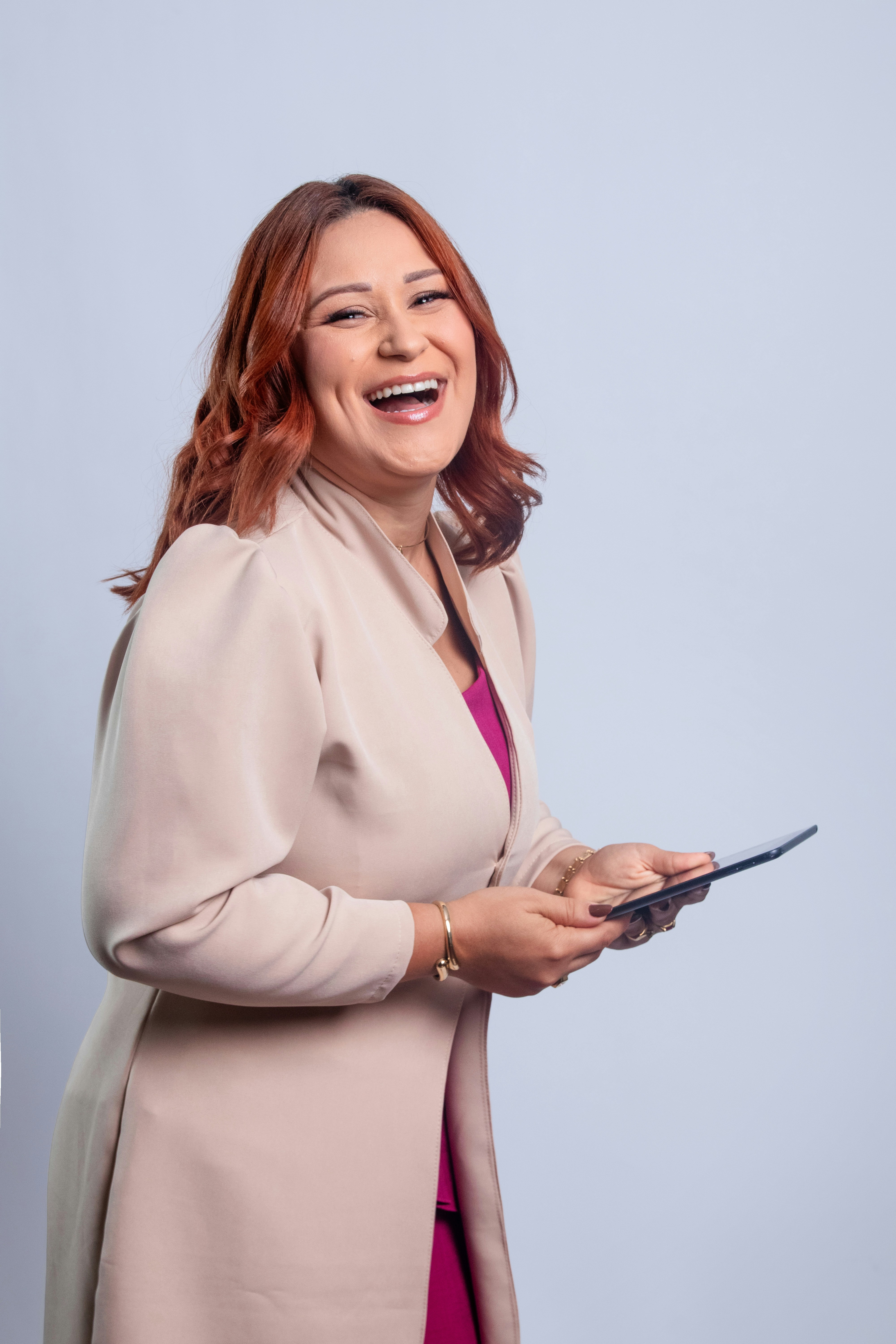 Joyful Studio Moment: Confident Professional with Tablet