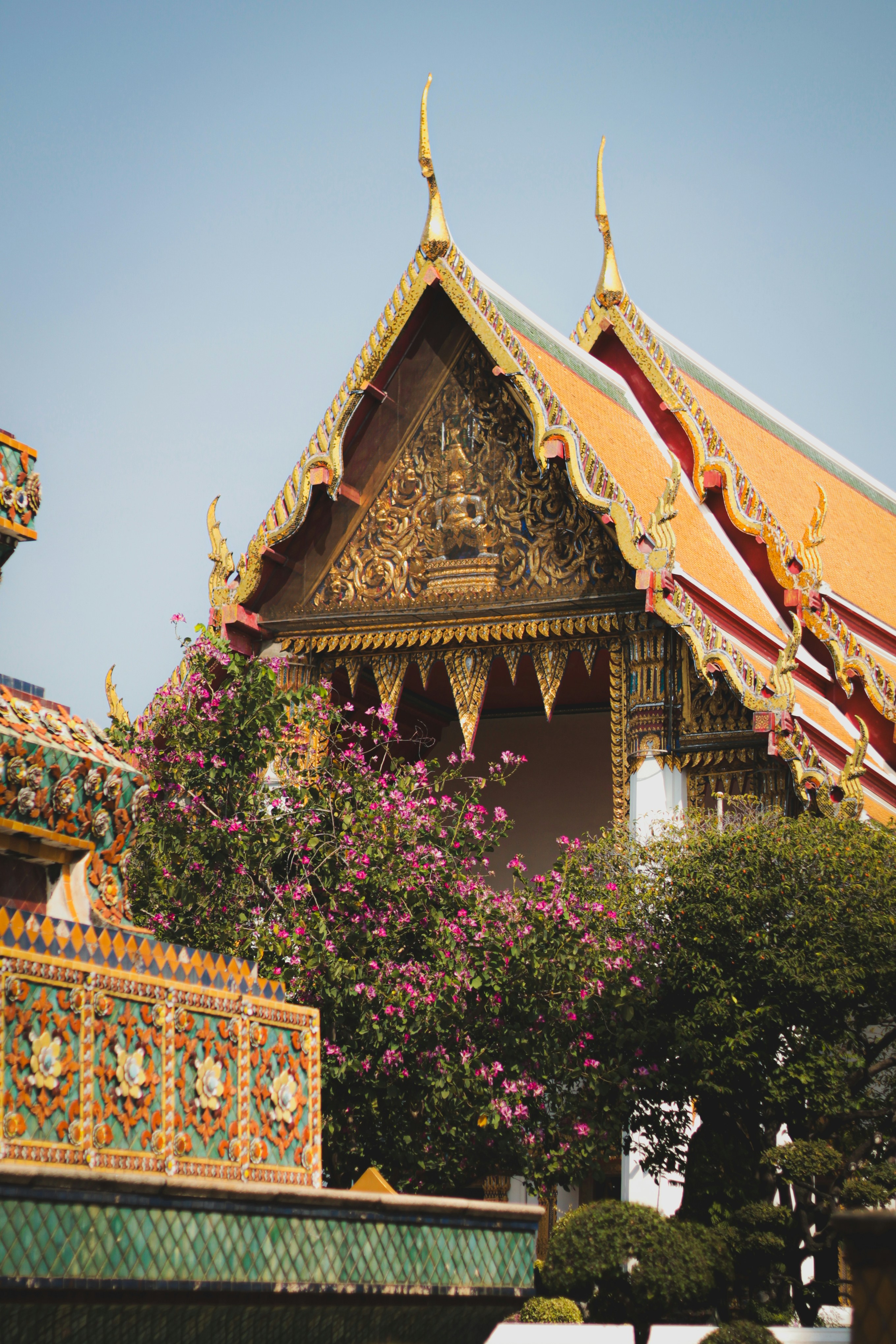 Intricate temple architecture adorned with vibrant colors and floral elements, showcasing the harmony between nature and cultural heritage.