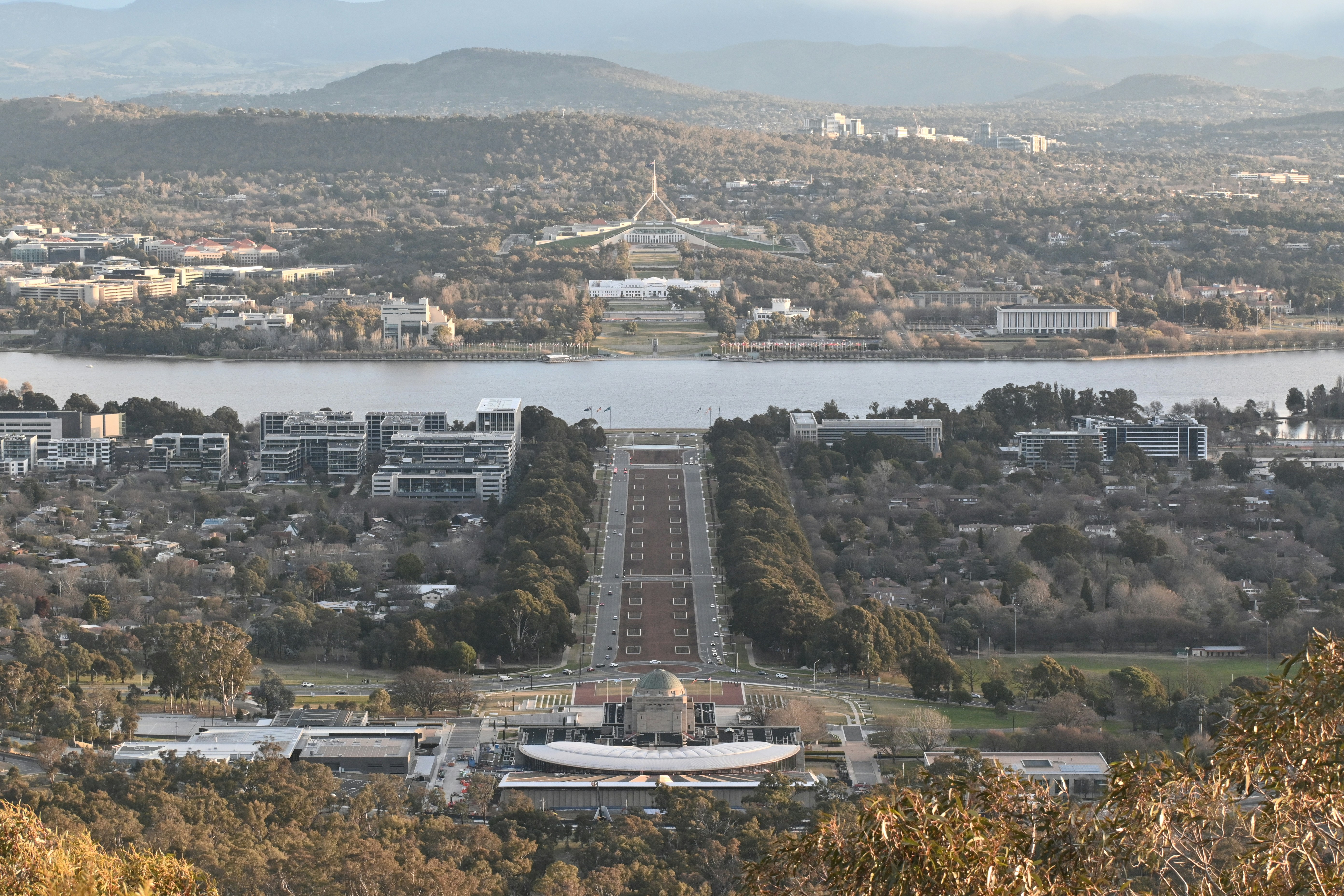 Cityscape with a long avenue leading to a domed building.