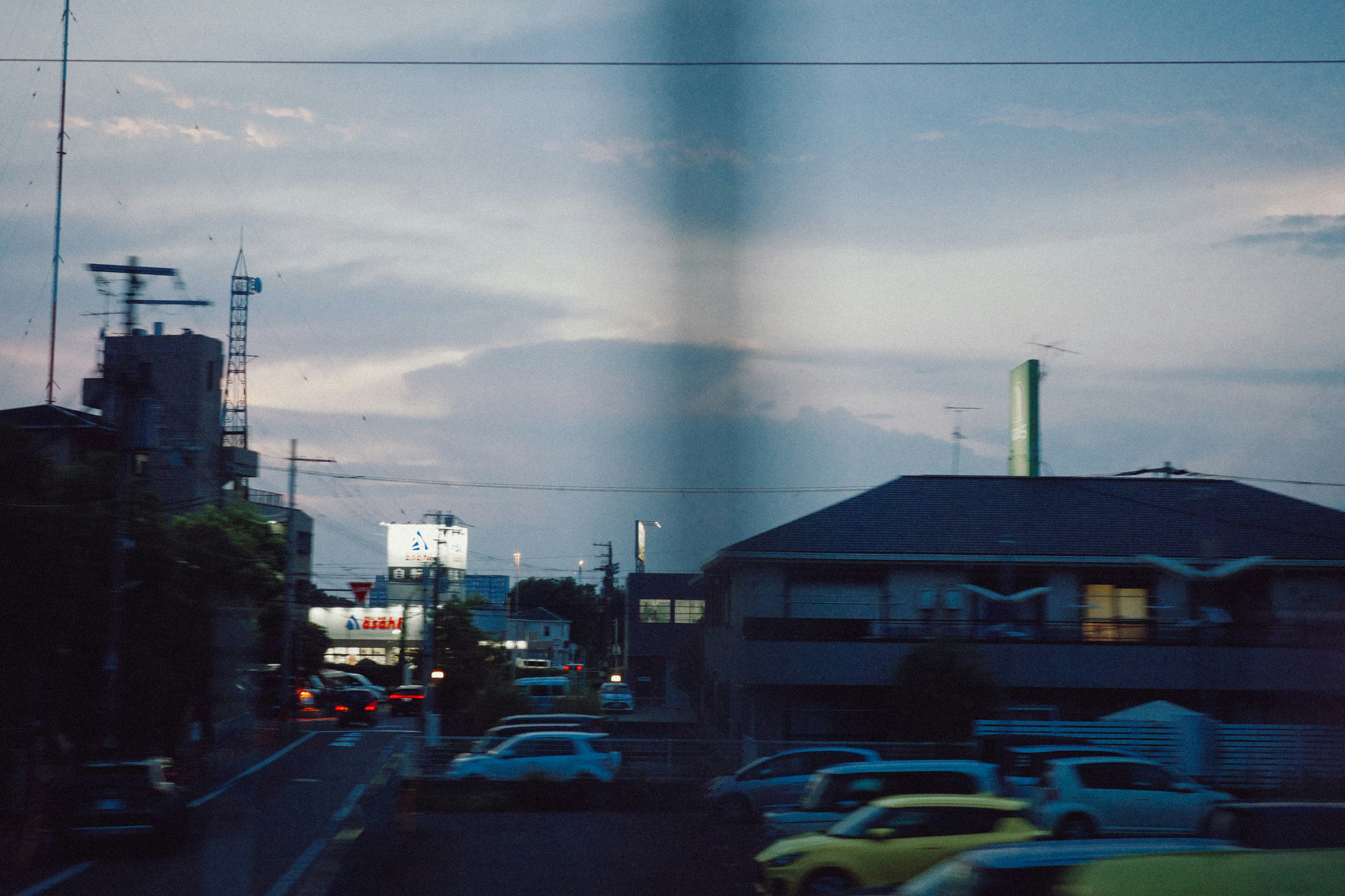 Street view with cars and buildings at dusk